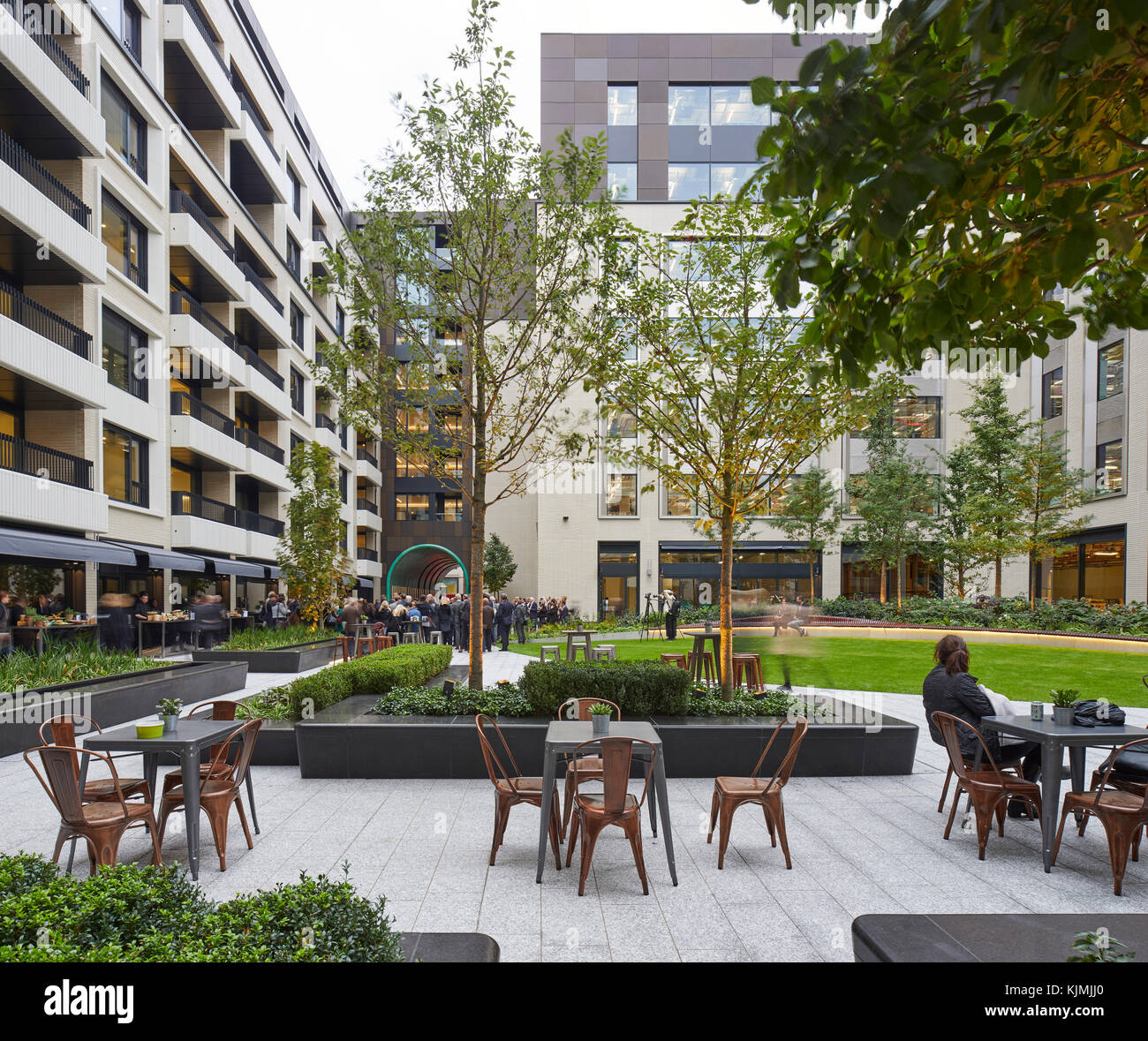 View of central courtyard with group of people attending opening event ...