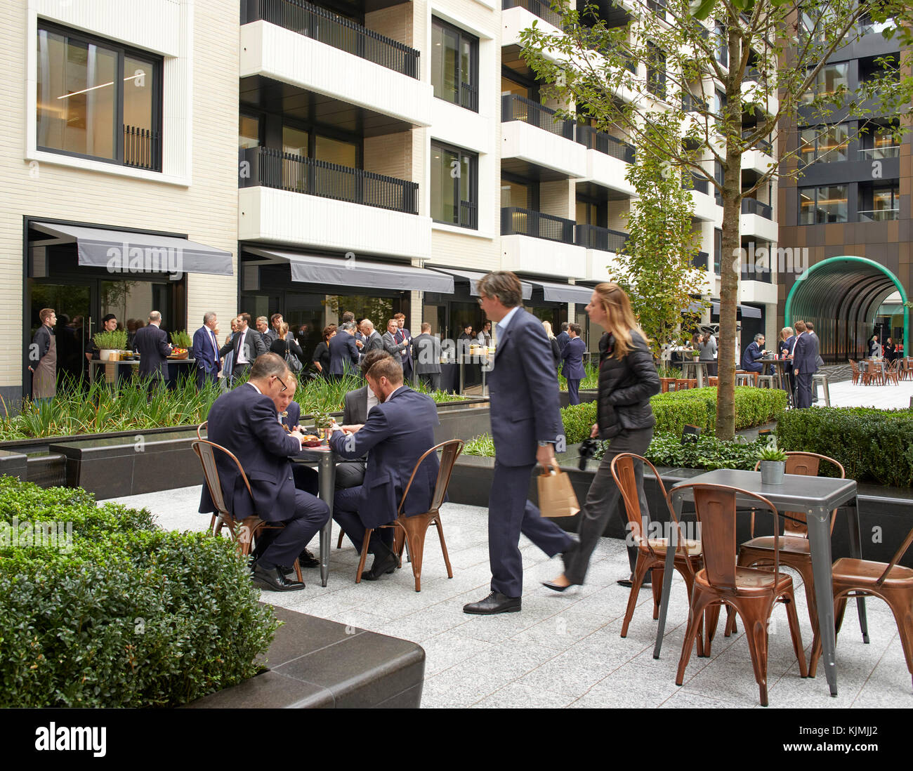 View of central courtyard with group of people attending opening event ...