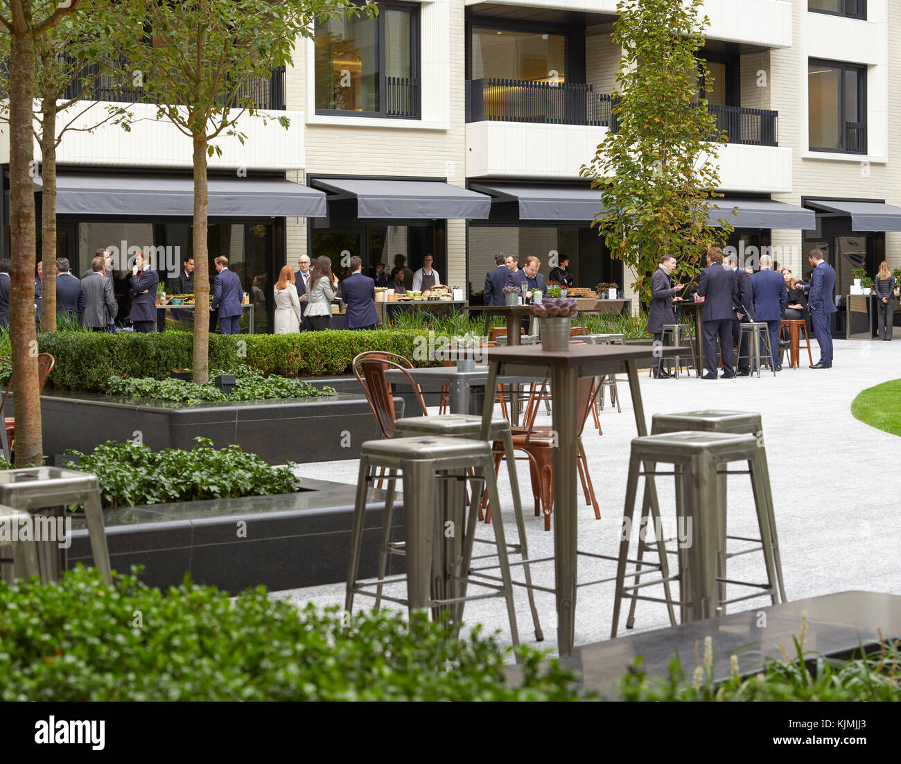 View of central courtyard with group of people attending opening event ...