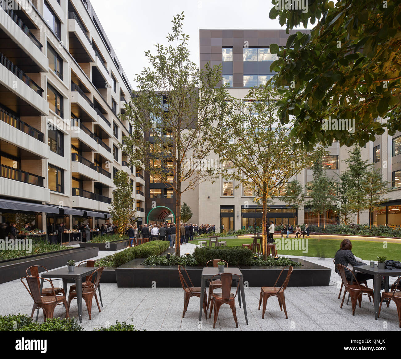 View of central courtyard with group of people attending opening event ...