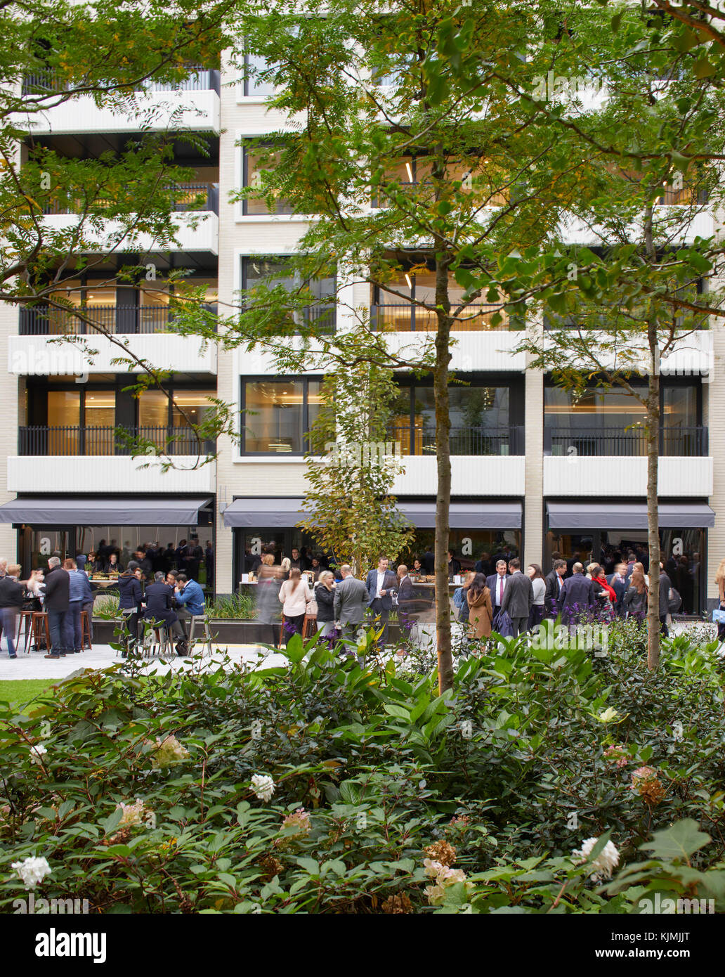 View of central courtyard with group of people attending opening event ...