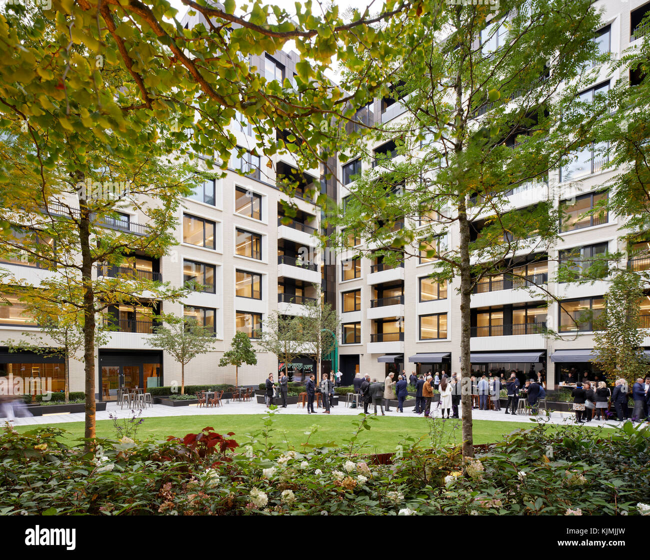 View of central courtyard with group of people attending opening event ...