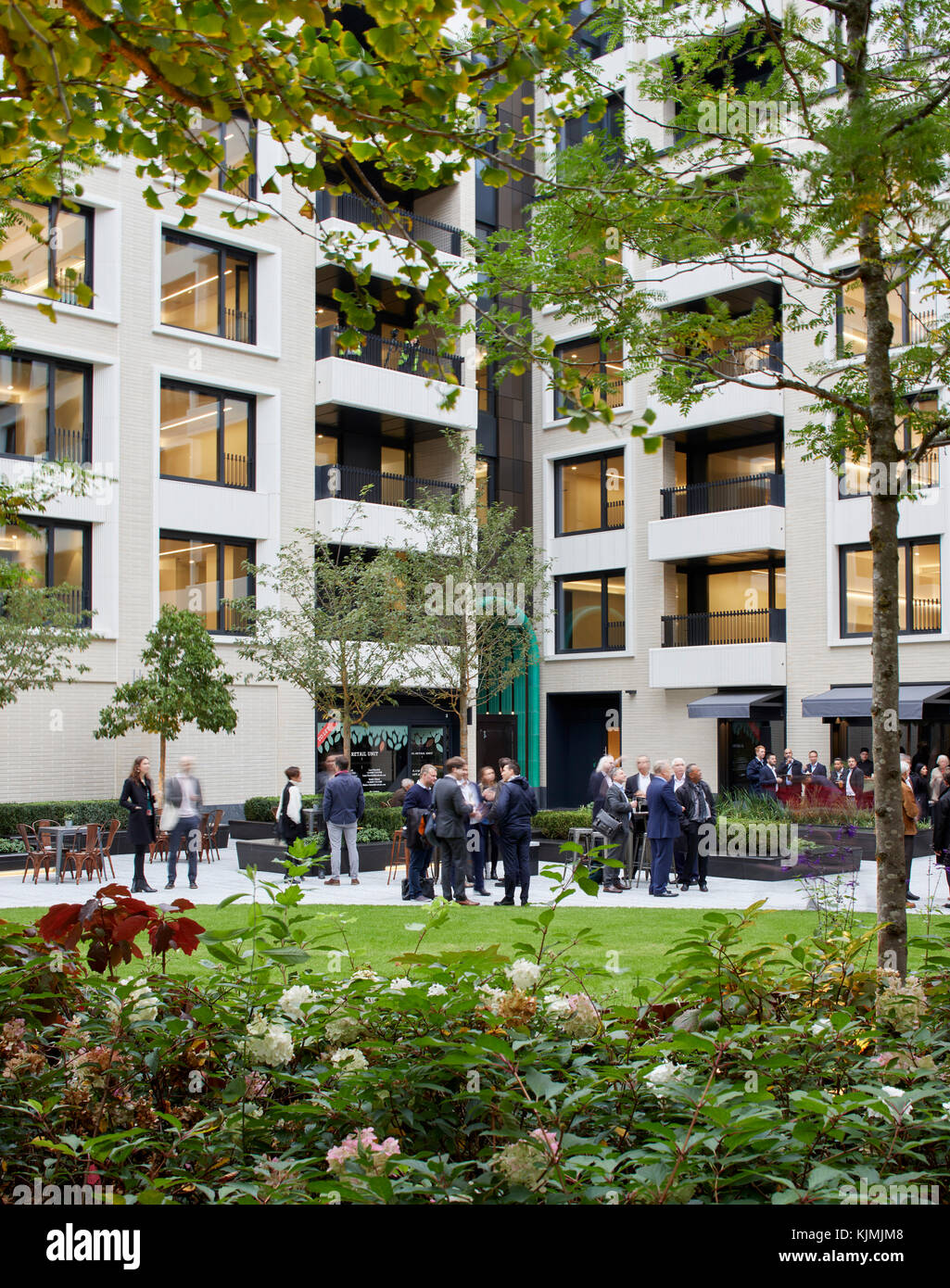 View of central courtyard with group of people attending opening event ...