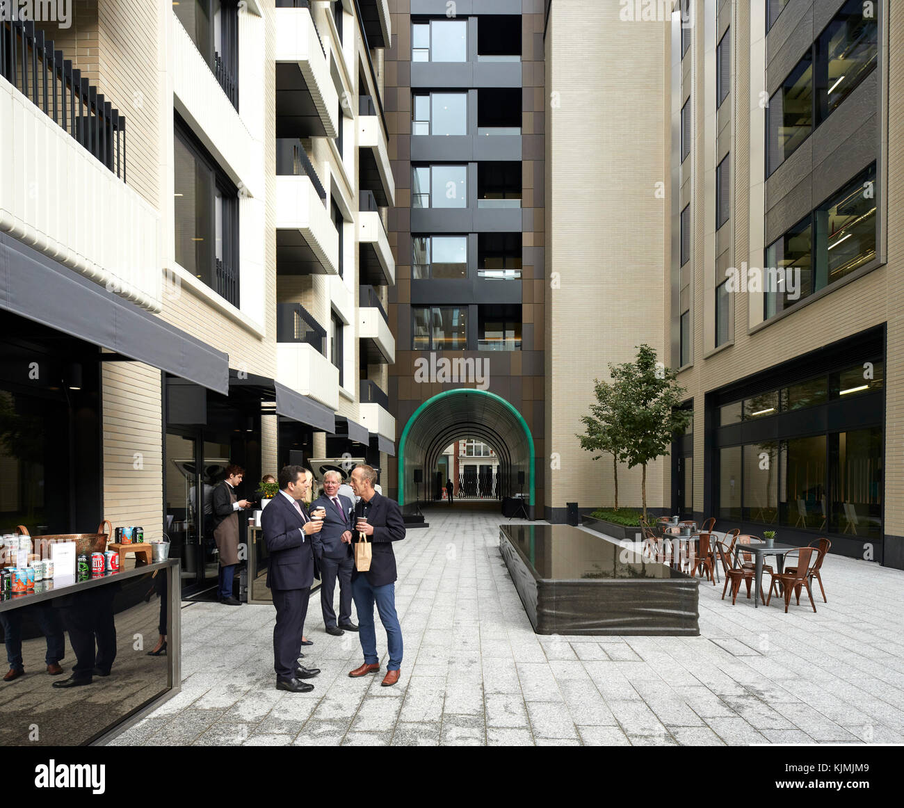 View of central courtyard with group of people attending opening event ...