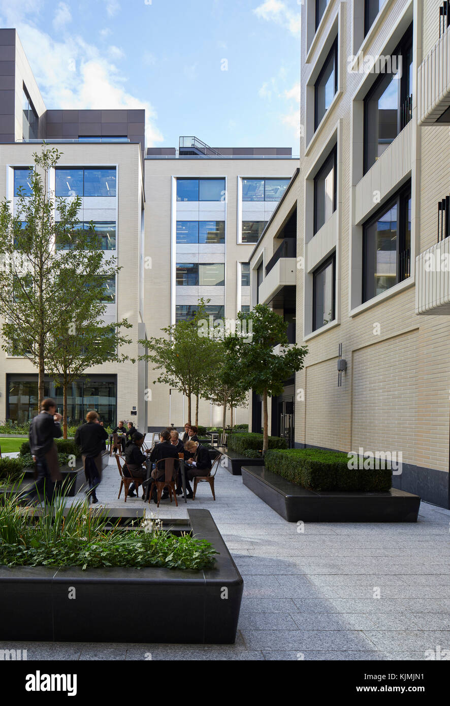 View of central courtyard with group of people attending opening event ...