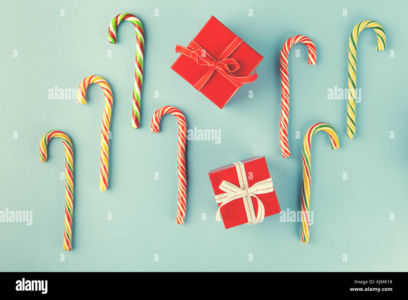 Christmas red gift boxes and Candy canes onblue background. Flat lay ...