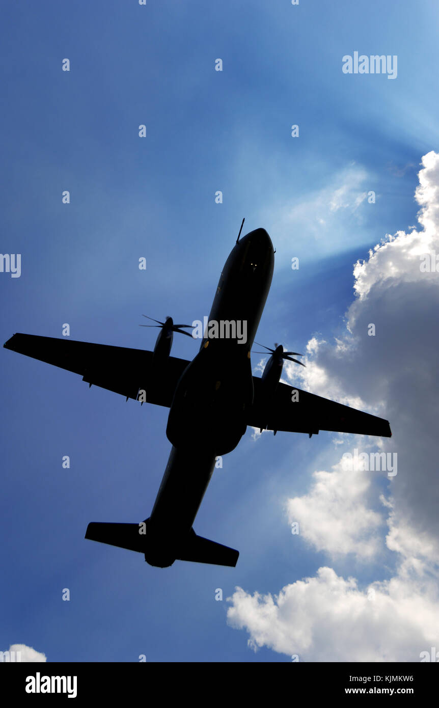 final-approach landing silhouette with nose refuelling probe and clouds ...