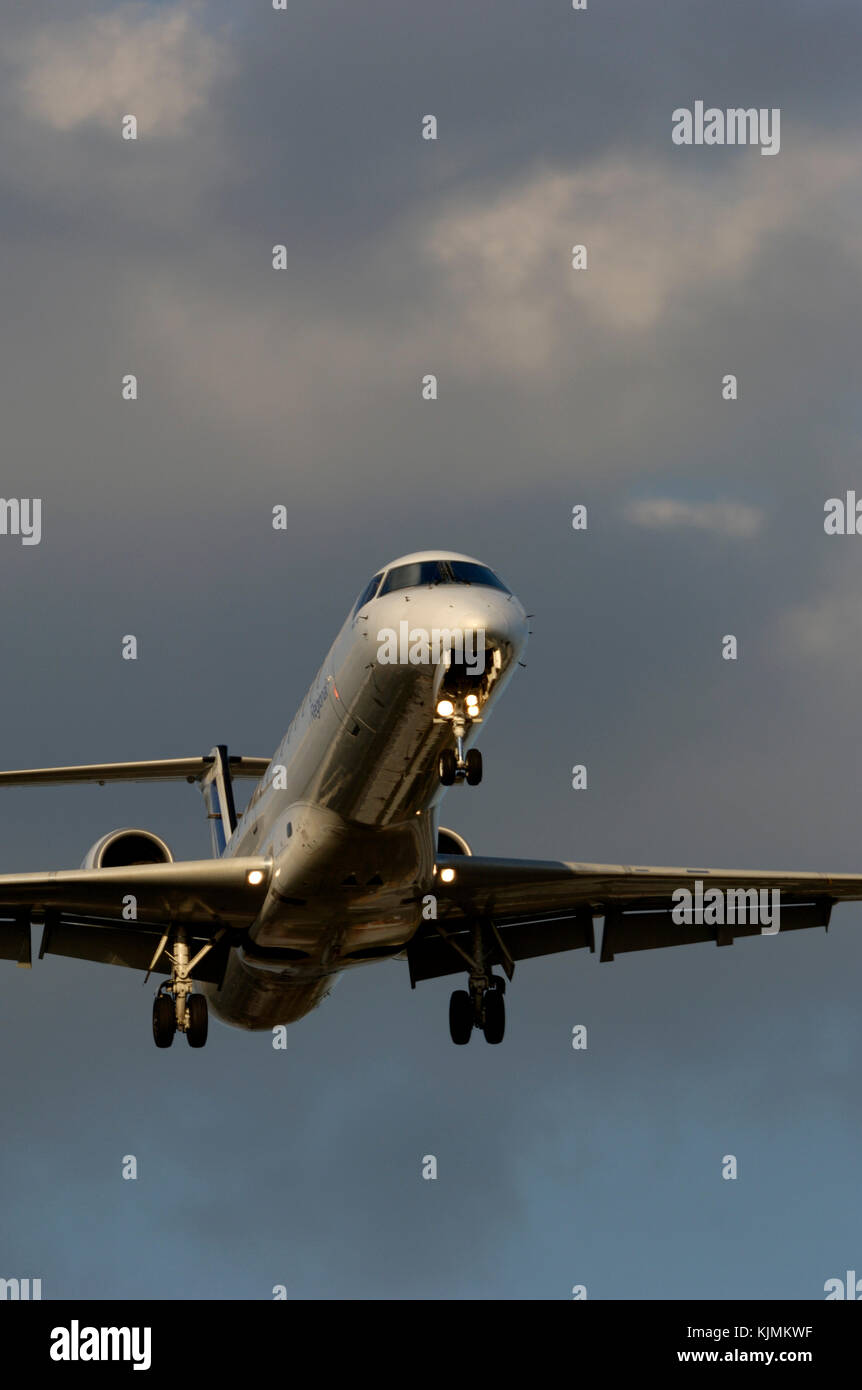 final-approach landing with dark clouds behind Stock Photo - Alamy