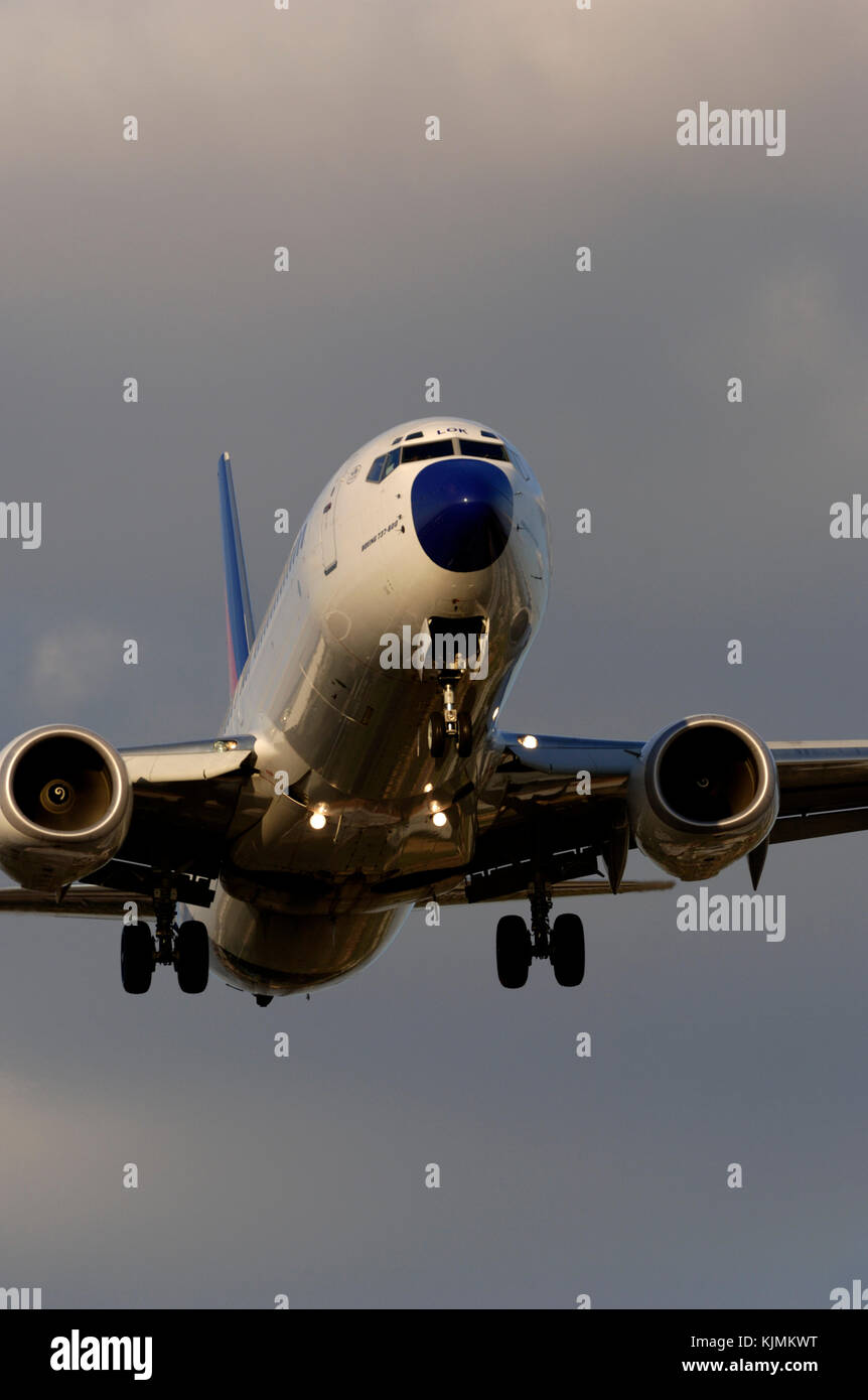 final-approach landing with dark clouds behind Stock Photo - Alamy
