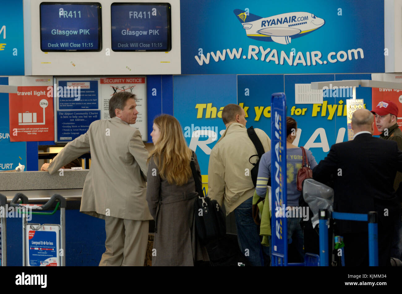 passengers queue in the main terminal Ryanair check-in concourse for a ...
