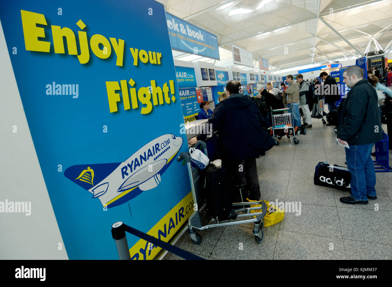 Ryanair passengers in a queue for check-in in the main terminal with an ...
