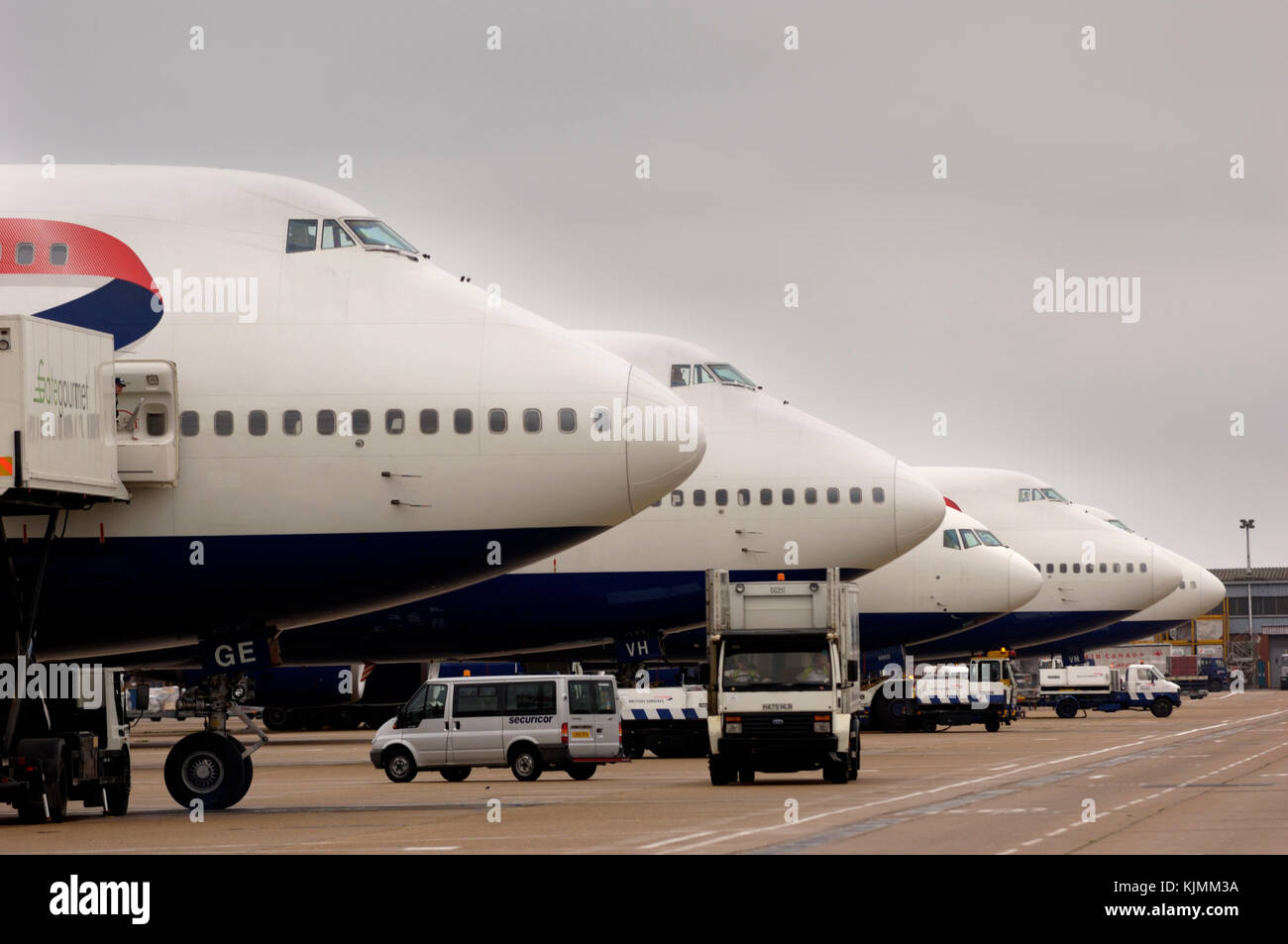 Busy airside road traffic, support vehicles, and a row of British ...