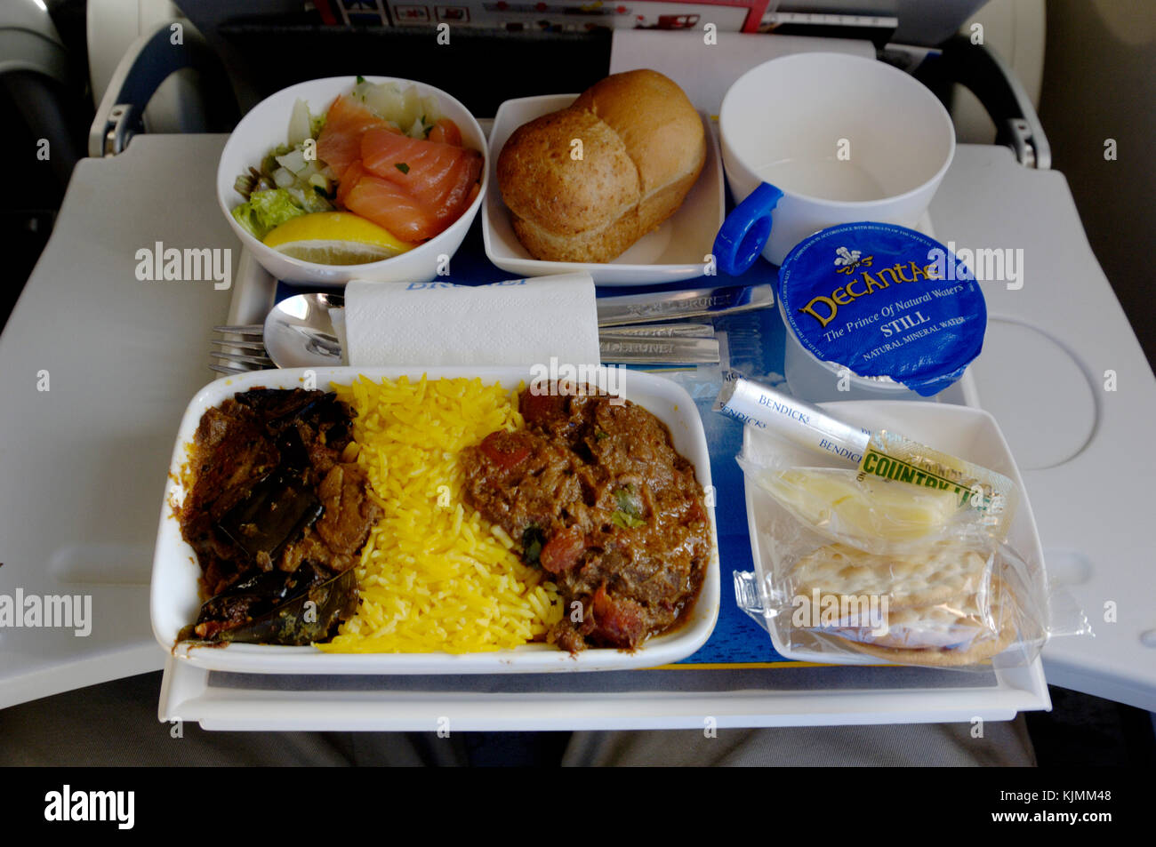 In-flight meal. A tray packed with a three course hot meal, rice, lamb ...