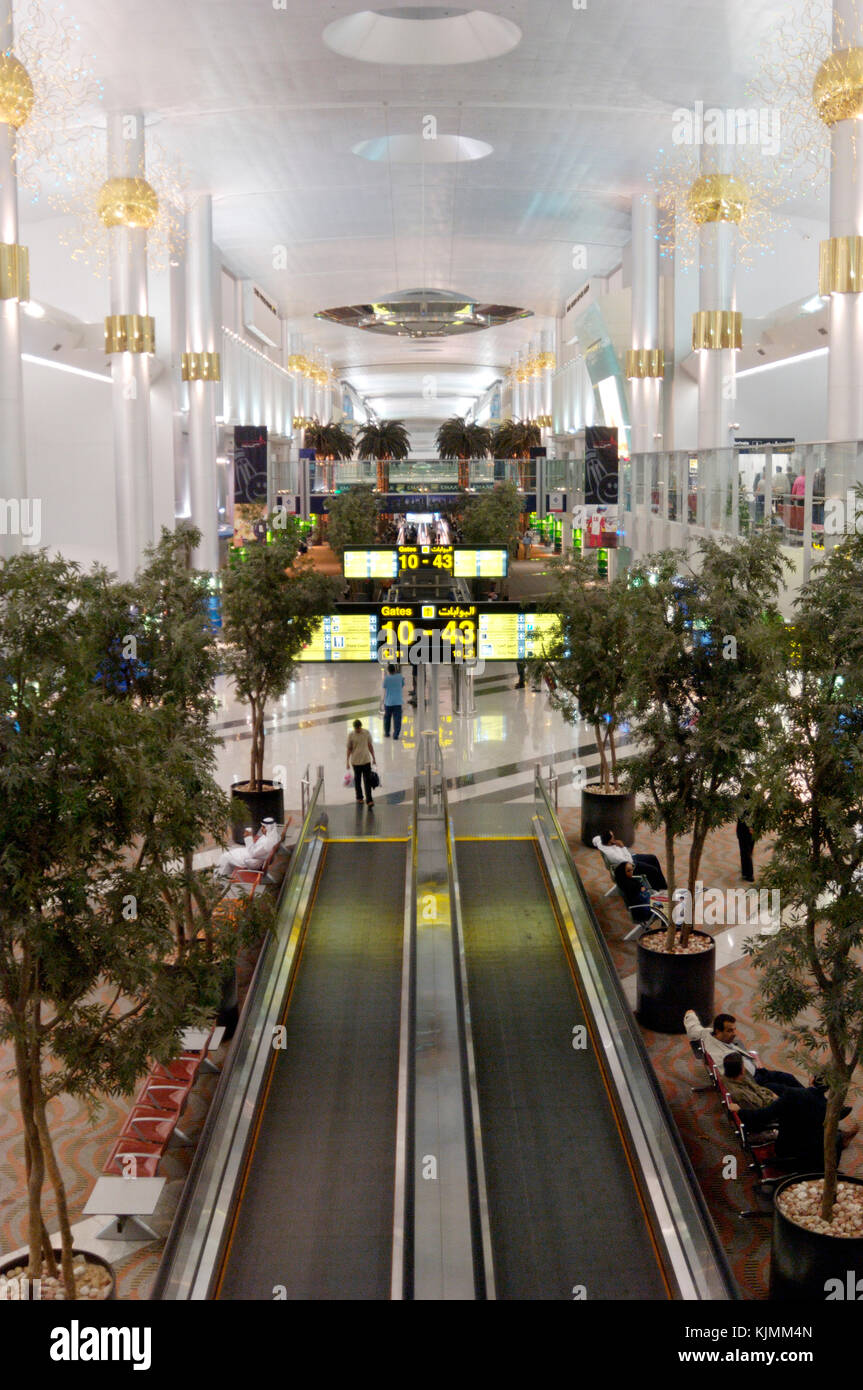 Passengers using travelators, and signs in the departures area in the ...