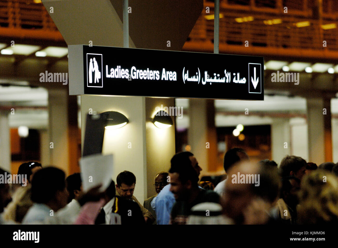 greeters and businessmen waiting below a 'Ladies Greeters area ...