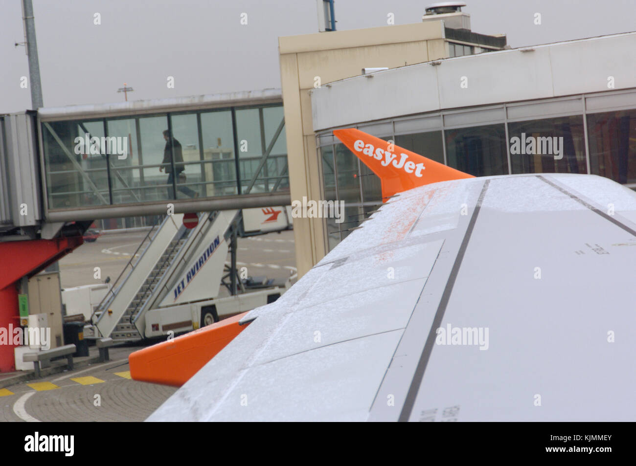 passenger walking in an airbridge with an A319 wing an winglet Stock ...