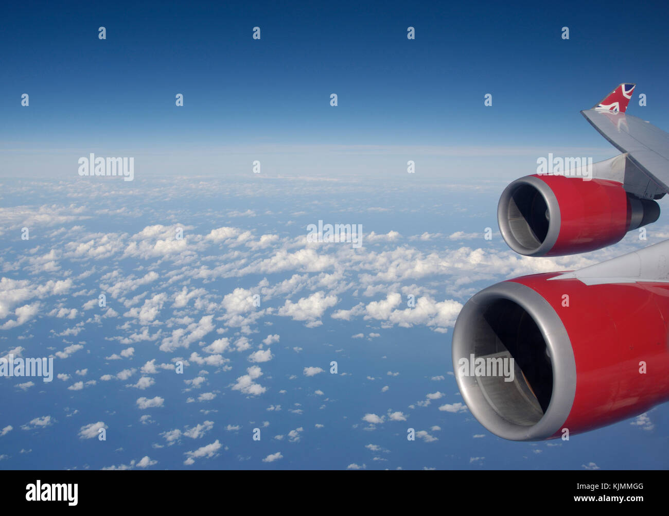 engines, winglet and wing flying enroute over clouds and the North ...