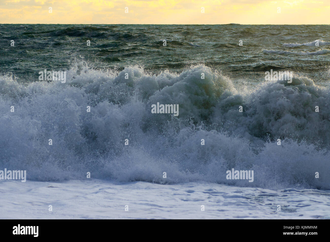 Beautiful shock of a sea storm wave on the beach at sunset Stock Photo ...