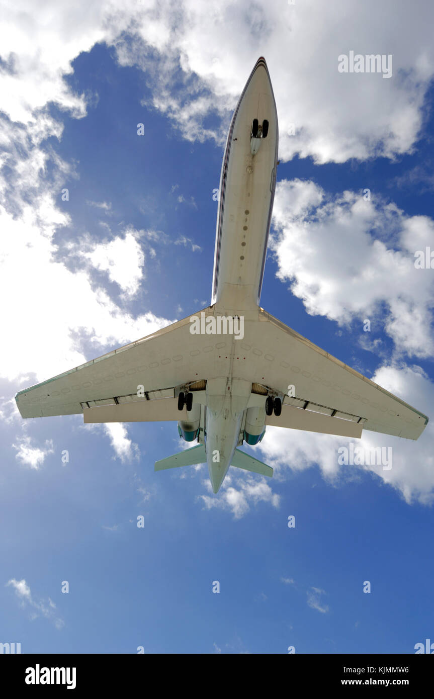 Gulfstream 400, low on final-approach to landing with cumulus clouds ...