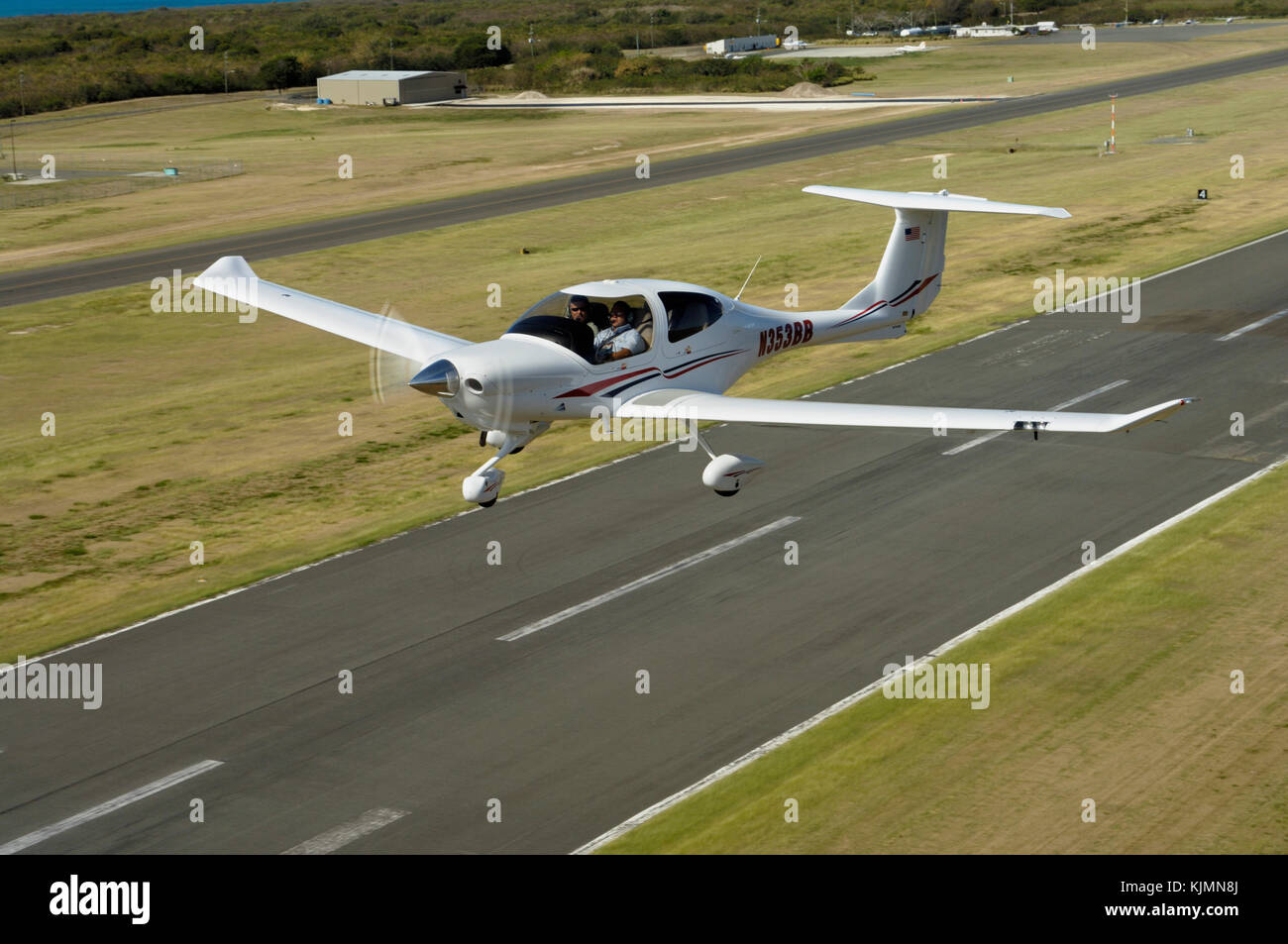 a Diamond DA-40 Diamond Star flying over the runway Stock Photo - Alamy