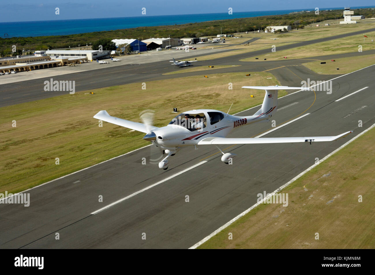 a Diamond DA-40 Diamond Star flying over the runway with a Skyways ...