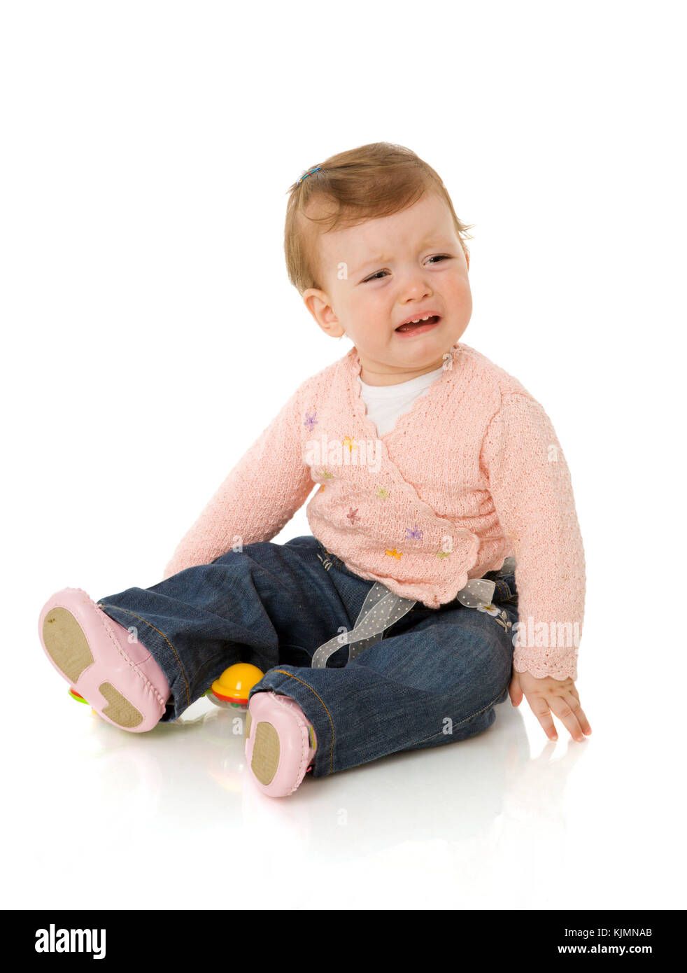 Crying little baby sitting isolated on white Stock Photo - Alamy