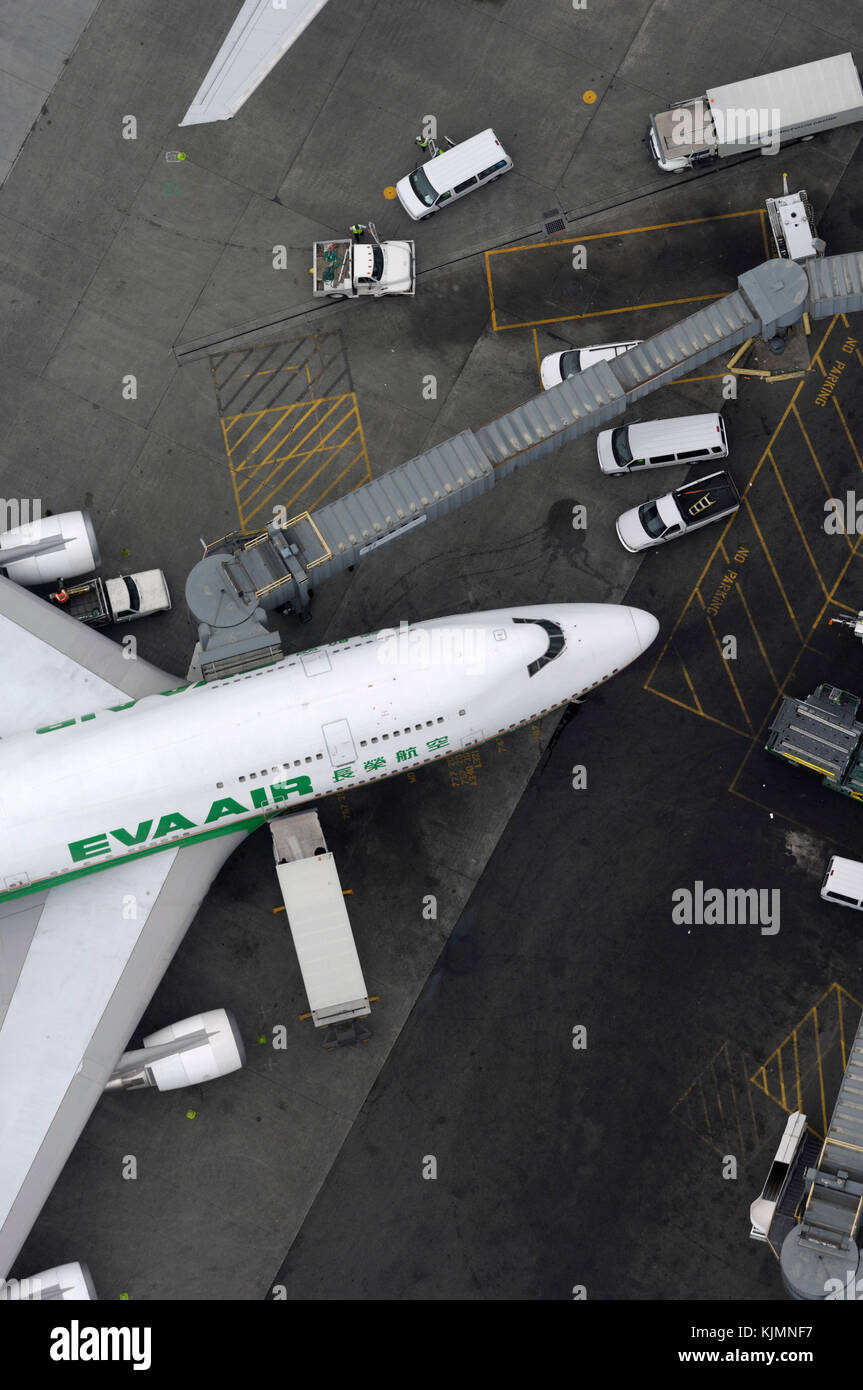 an EVA Air Boeing 747-400 parked at the terminal with jetway extended ...