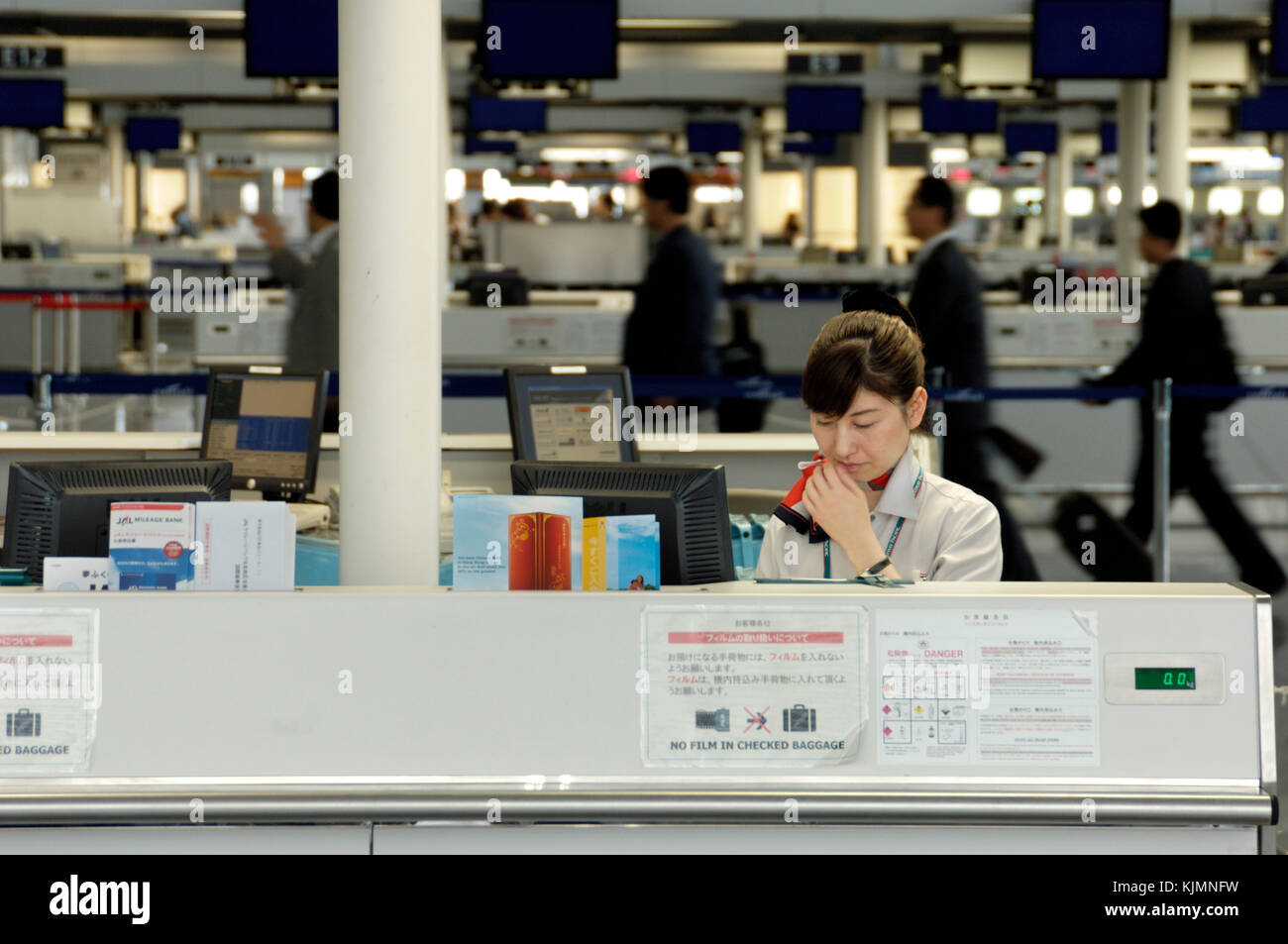 check-in desk and woman in the check-in area of the main terminal Stock ...