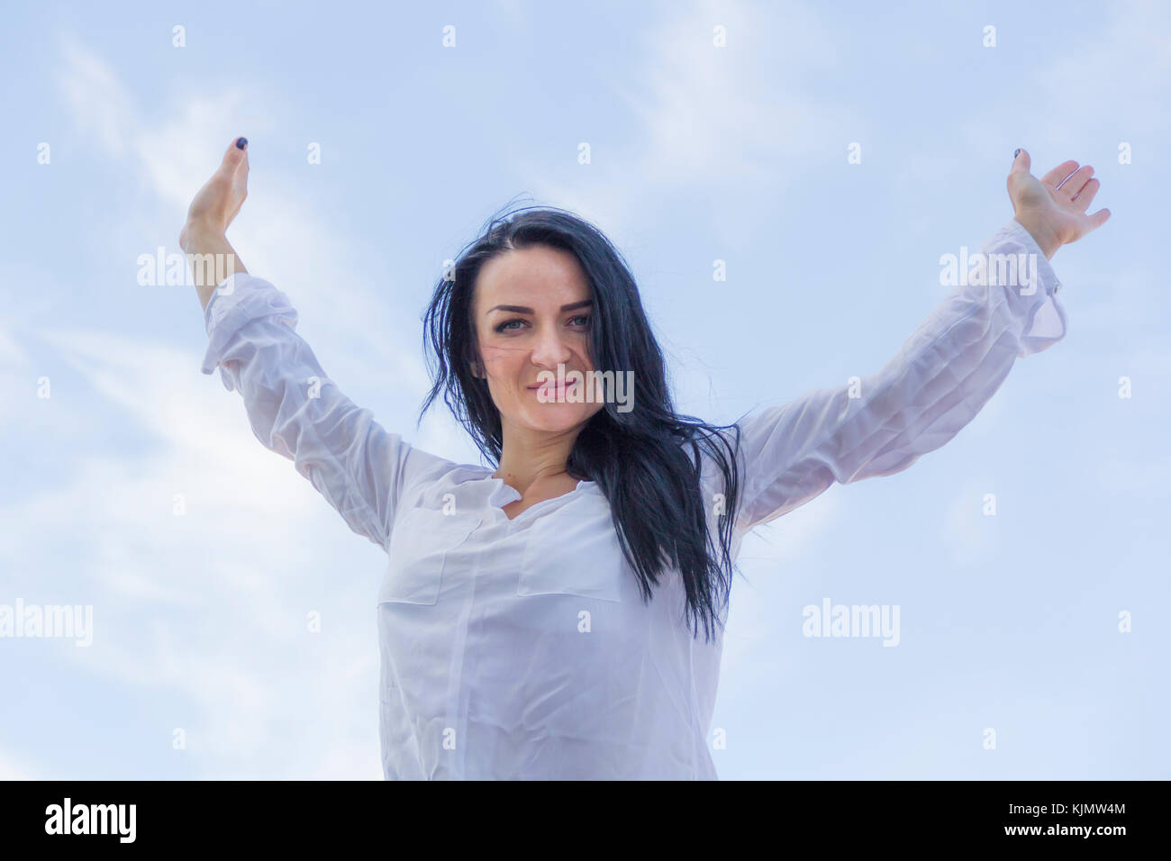 Photo of brunette woman with upward hands Stock Photo - Alamy