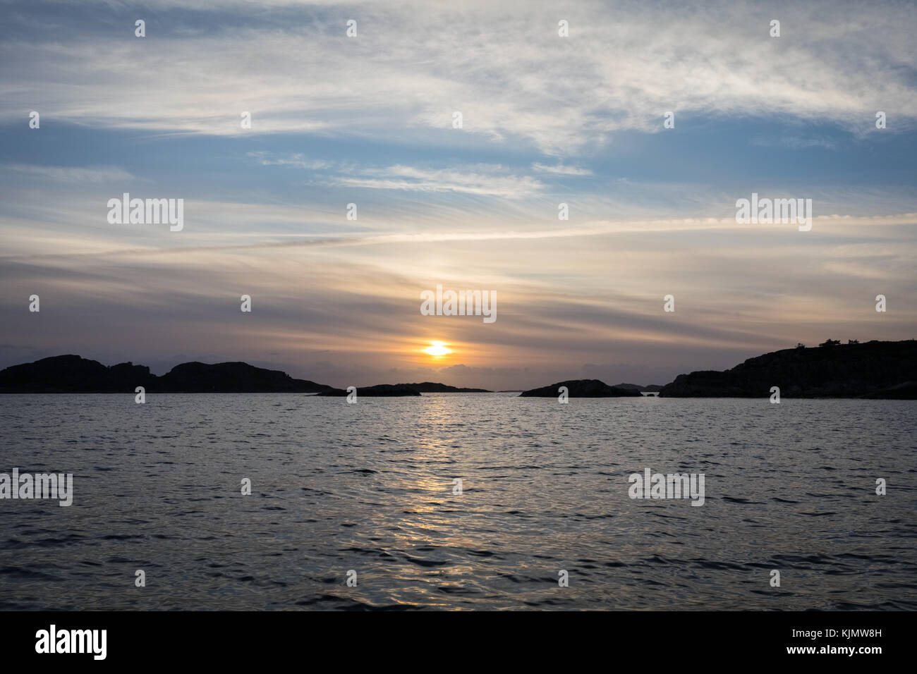 Sun is setting over the archipelago, sea and cloudy sky in Kristiansand ...