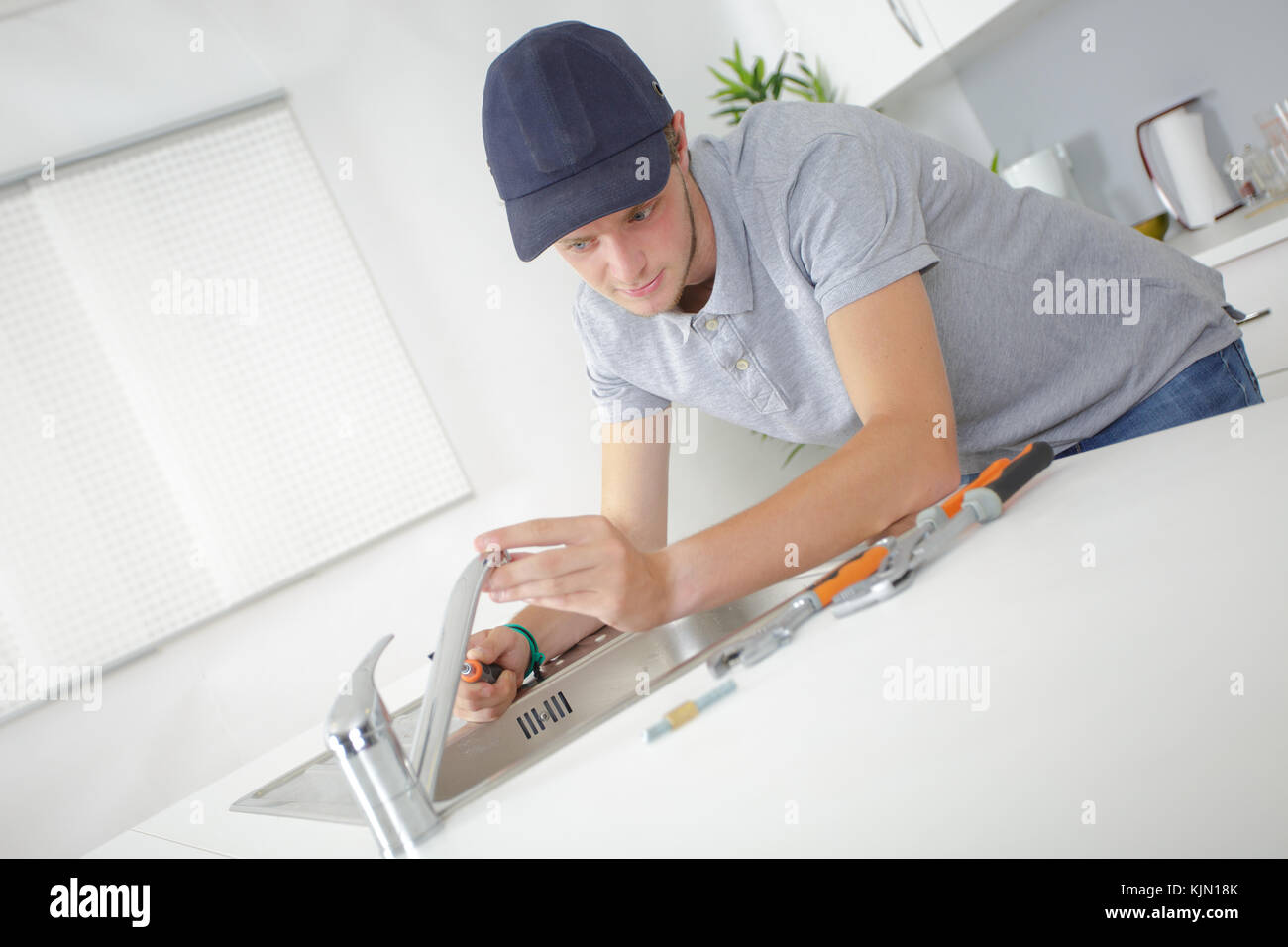 fixing the tap Stock Photo - Alamy