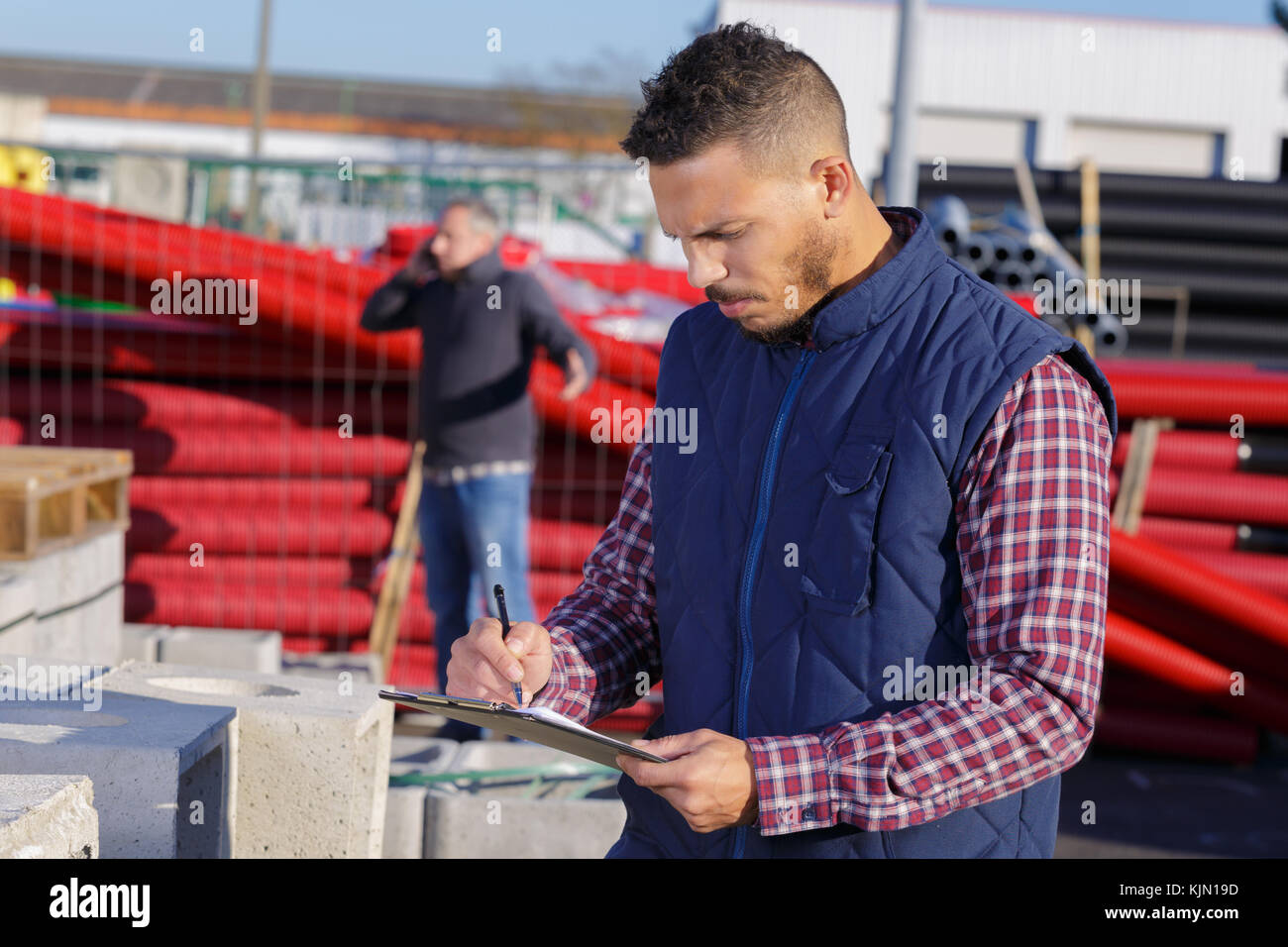 worker working outside a modern factory Stock Photo - Alamy