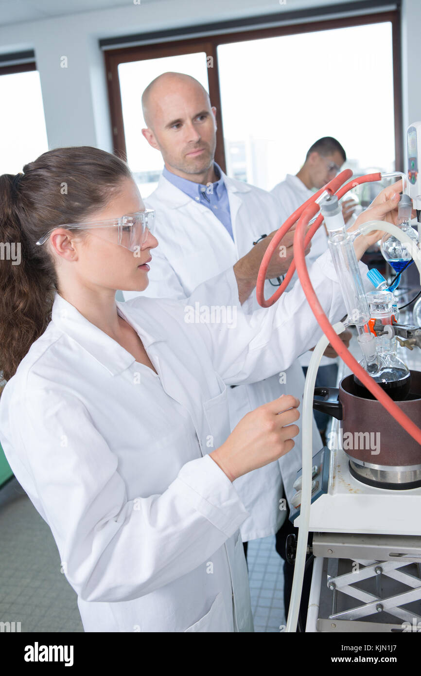 Science student holding length of rubber hose Stock Photo - Alamy