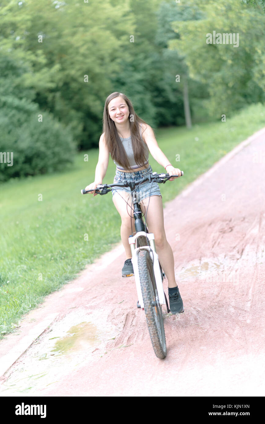 Girl teenager on a bicycle Stock Photo - Alamy