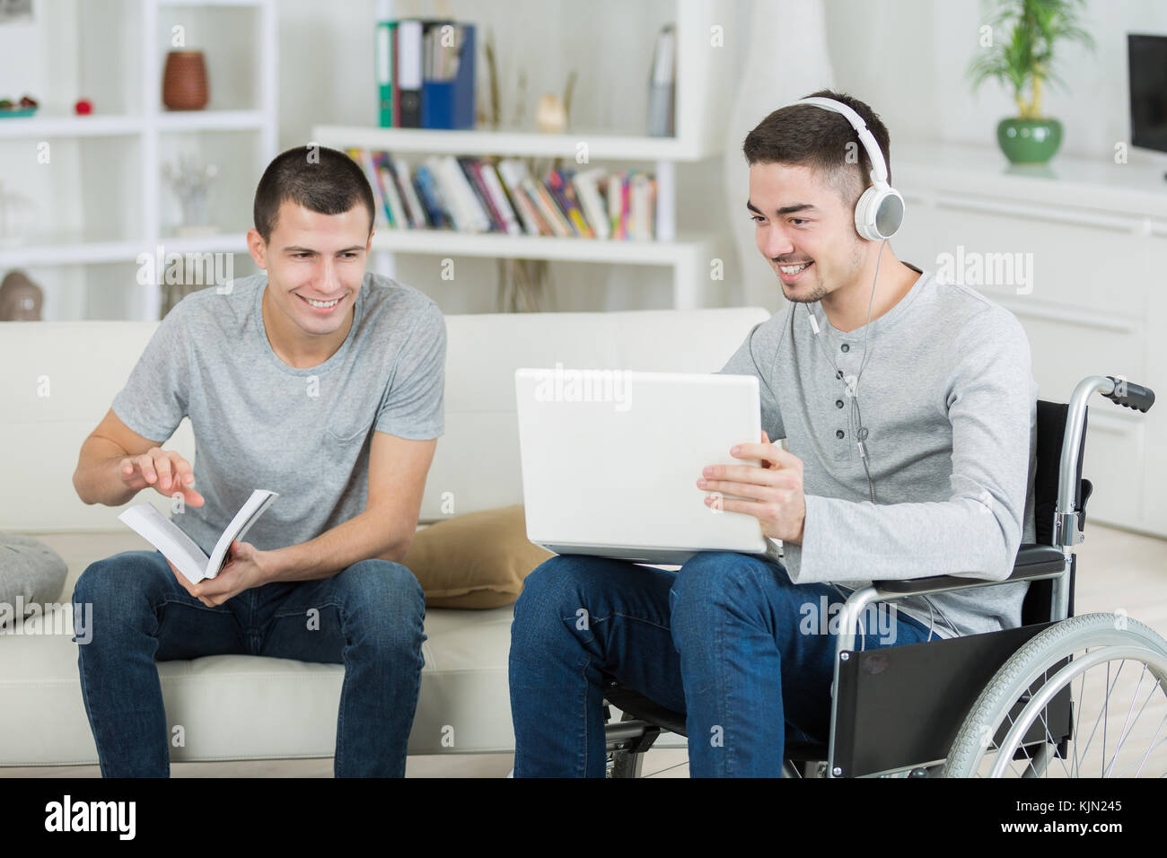 two male students going over their homework Stock Photo - Alamy
