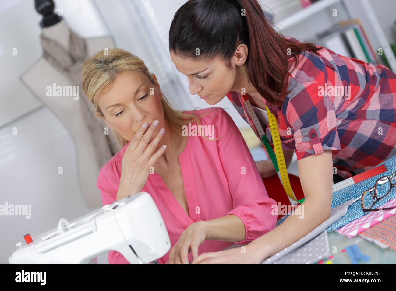 female dressmaker working with sewing machine Stock Photo - Alamy