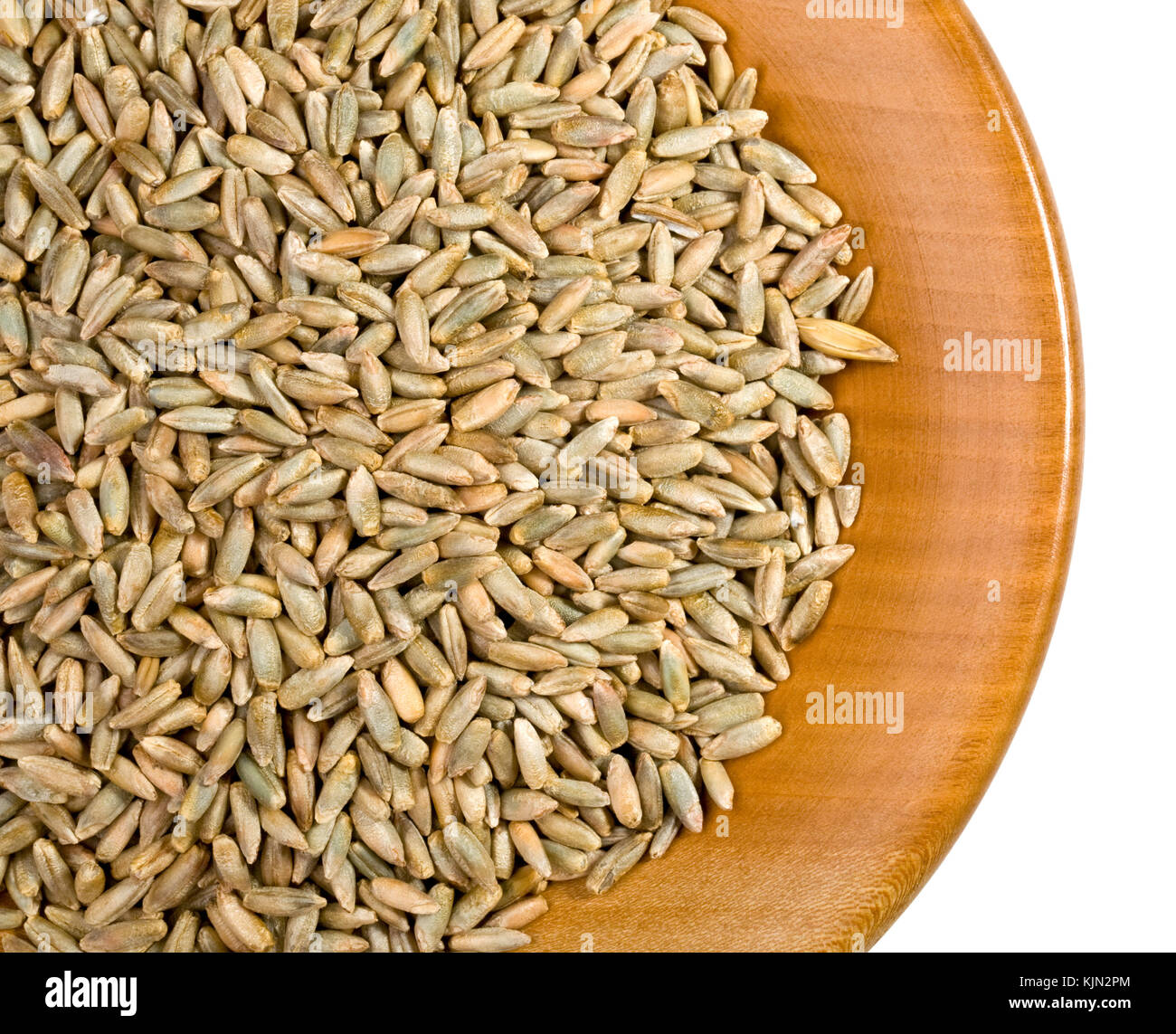 wooden plate with grains of dinkel, close-up Stock Photo - Alamy