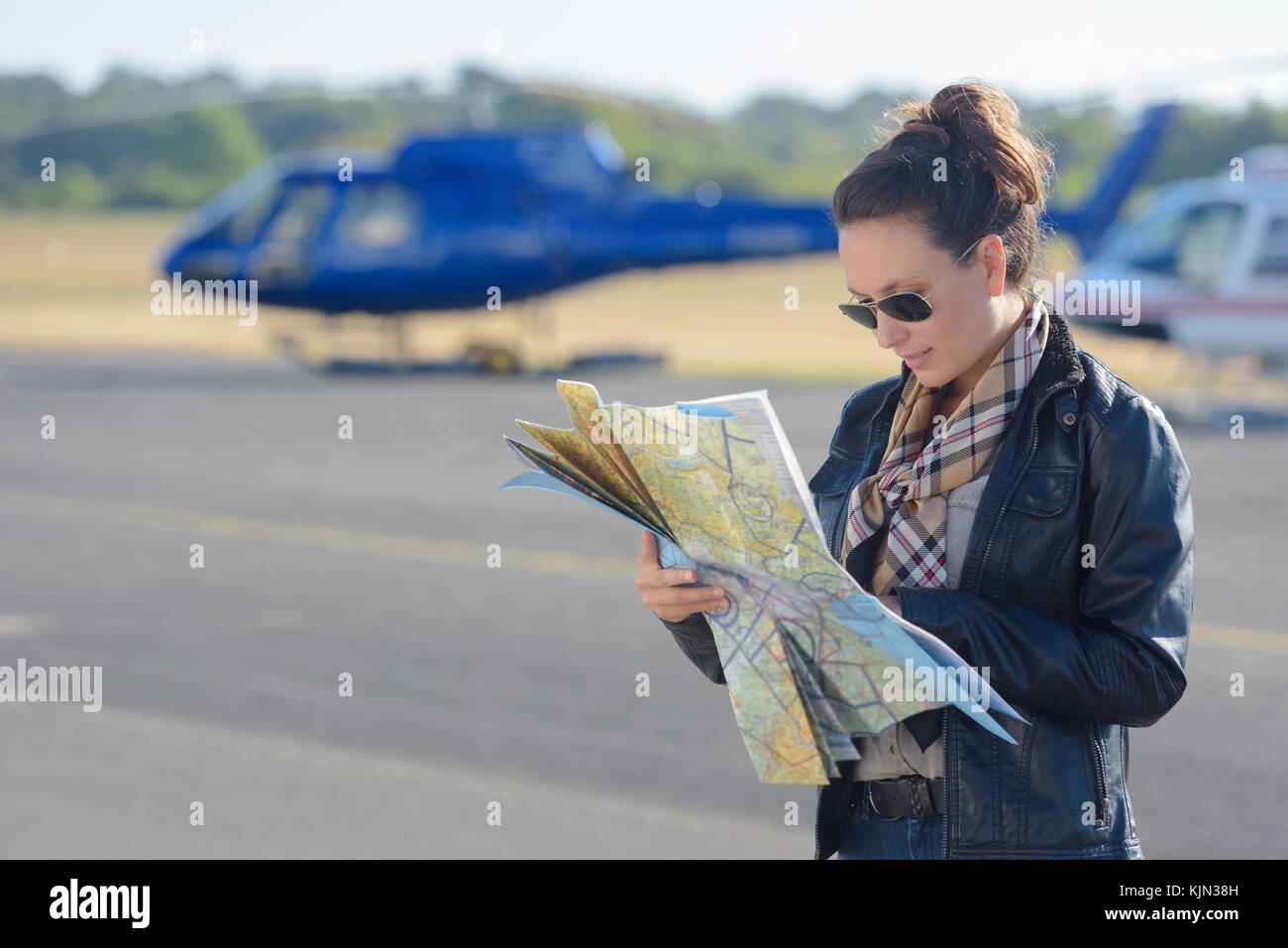 woman helicopter pilot reading map Stock Photo - Alamy