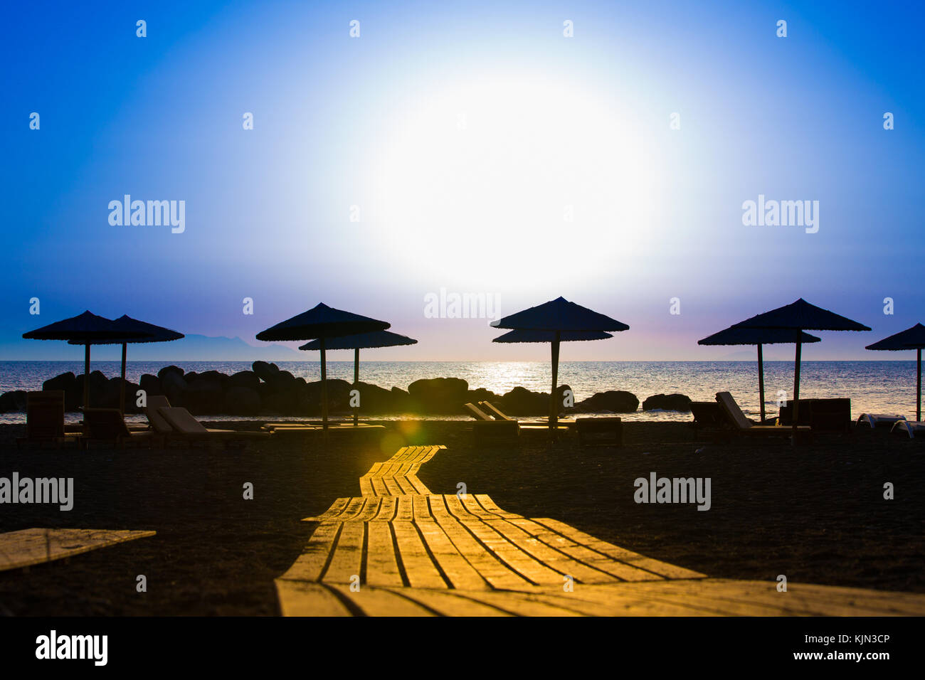 Wooden pavement on the beach at sunset time Stock Photo - Alamy
