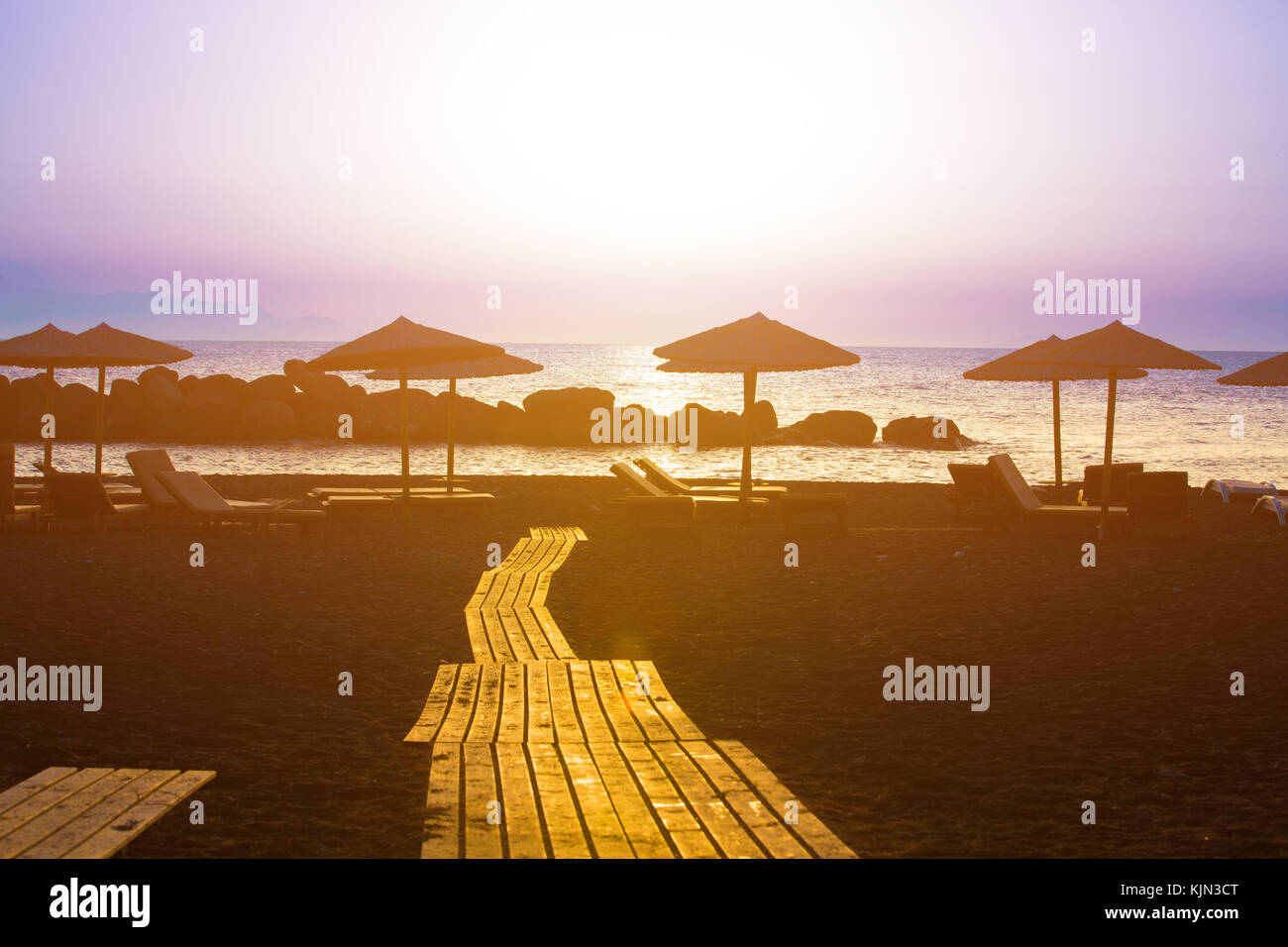 Wooden pavement on the beach at sunset time Stock Photo - Alamy