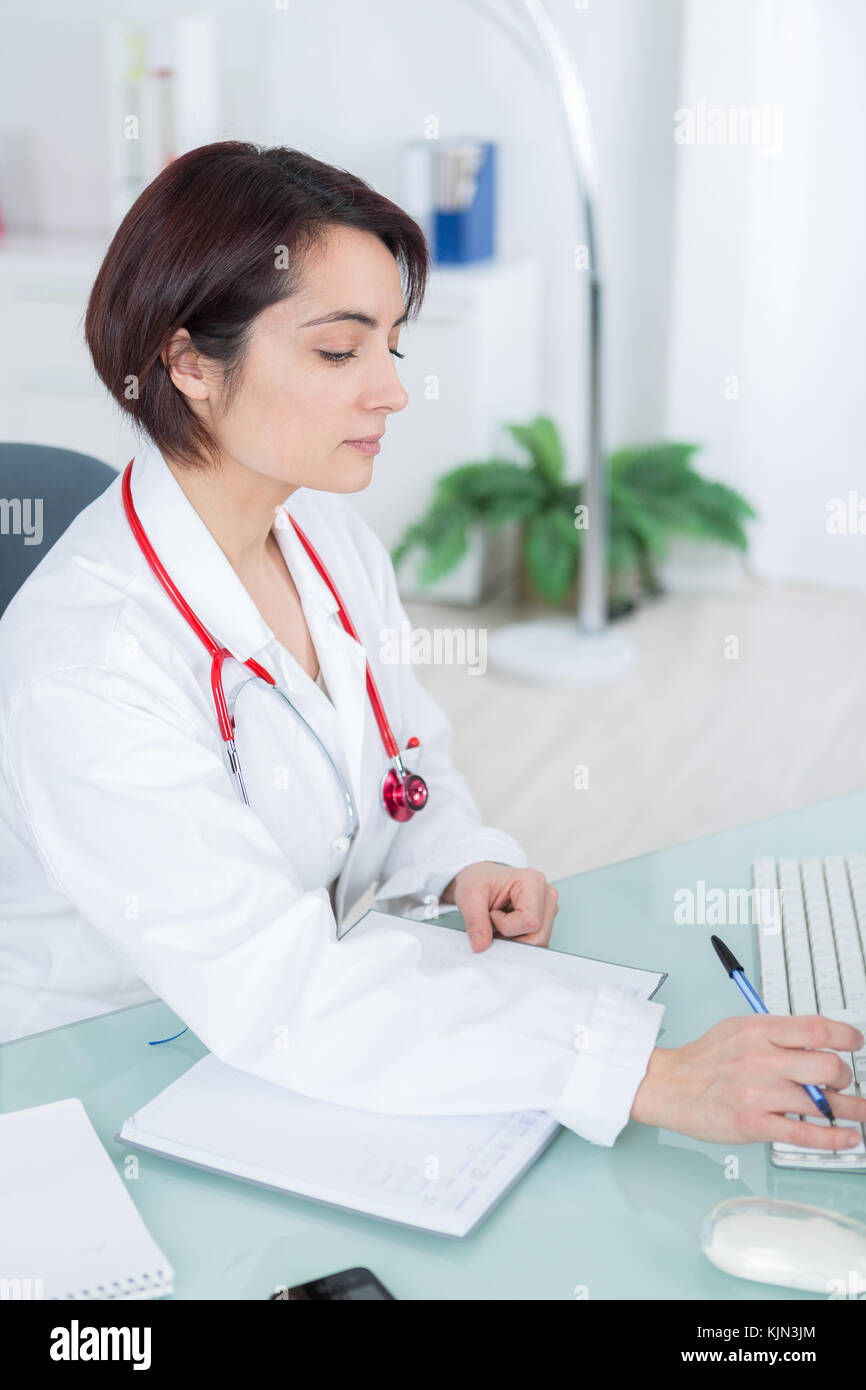 doctor woman working writing in a medical history Stock Photo - Alamy