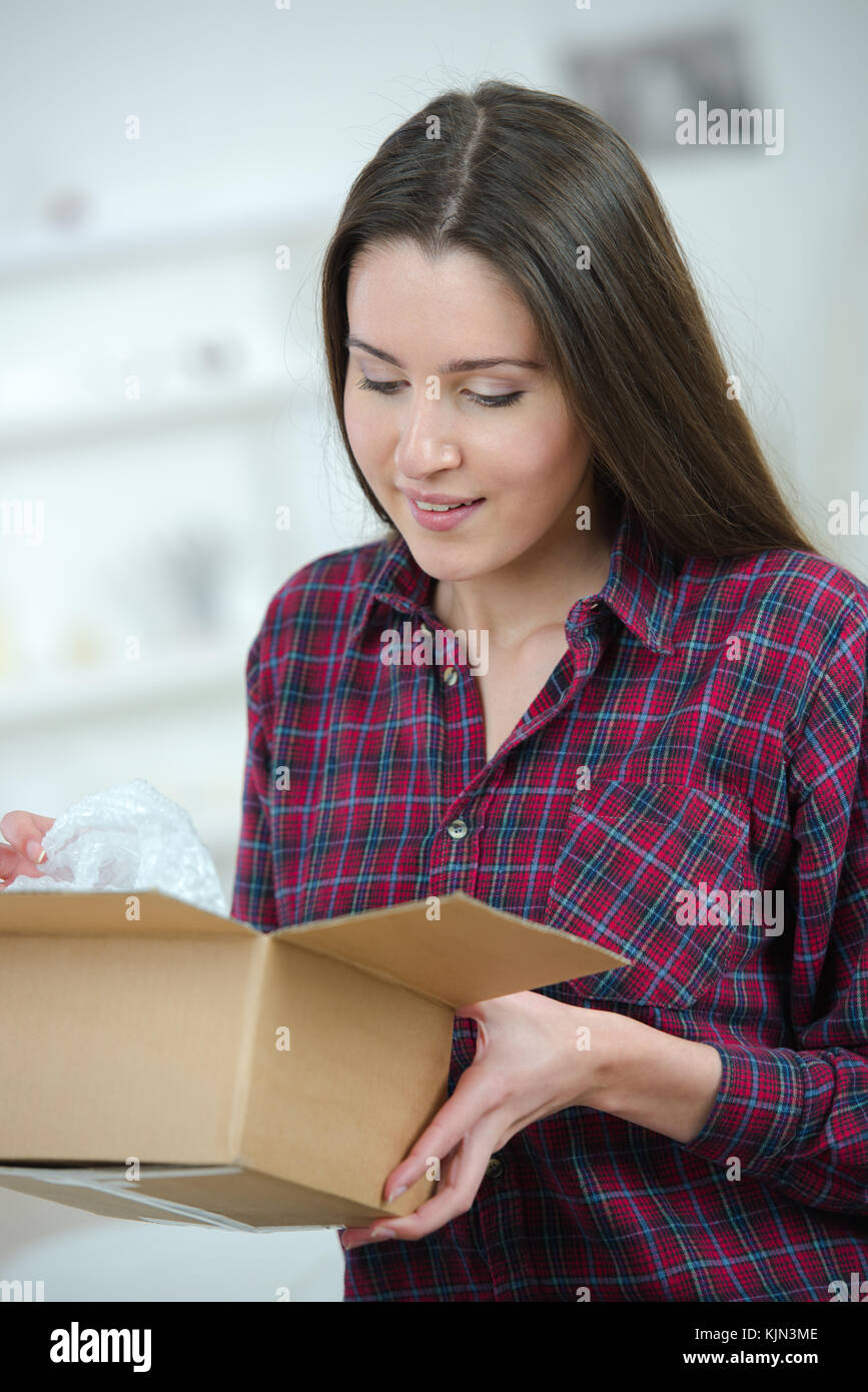 happy young woman opening a carton box Stock Photo - Alamy