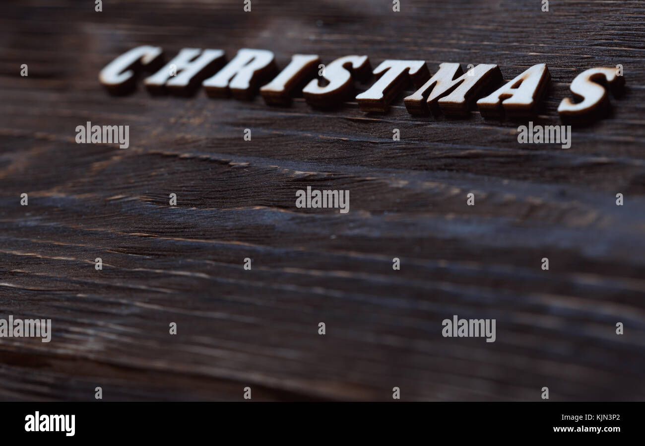 Christmas text on a wooden wall Stock Photo - Alamy