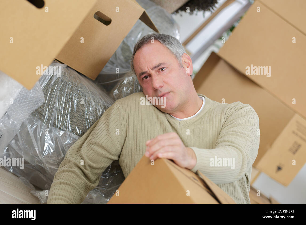 man tired from packing boxes during move Stock Photo - Alamy