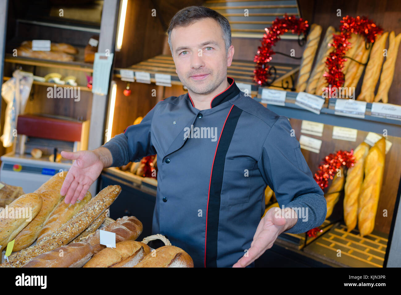 Baker presenting his range of breads Stock Photo - Alamy