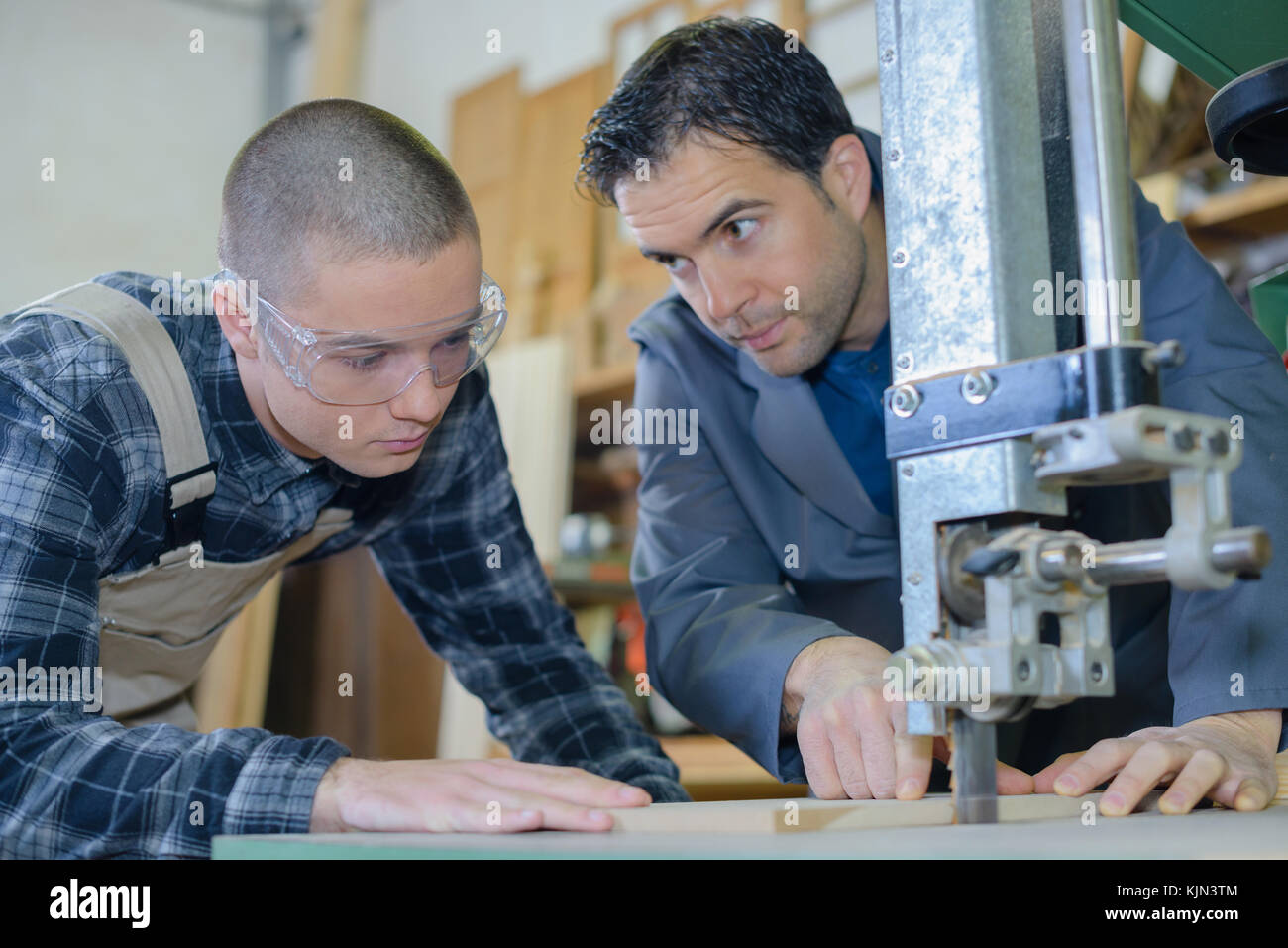 carpenter with apprentice in training period Stock Photo - Alamy