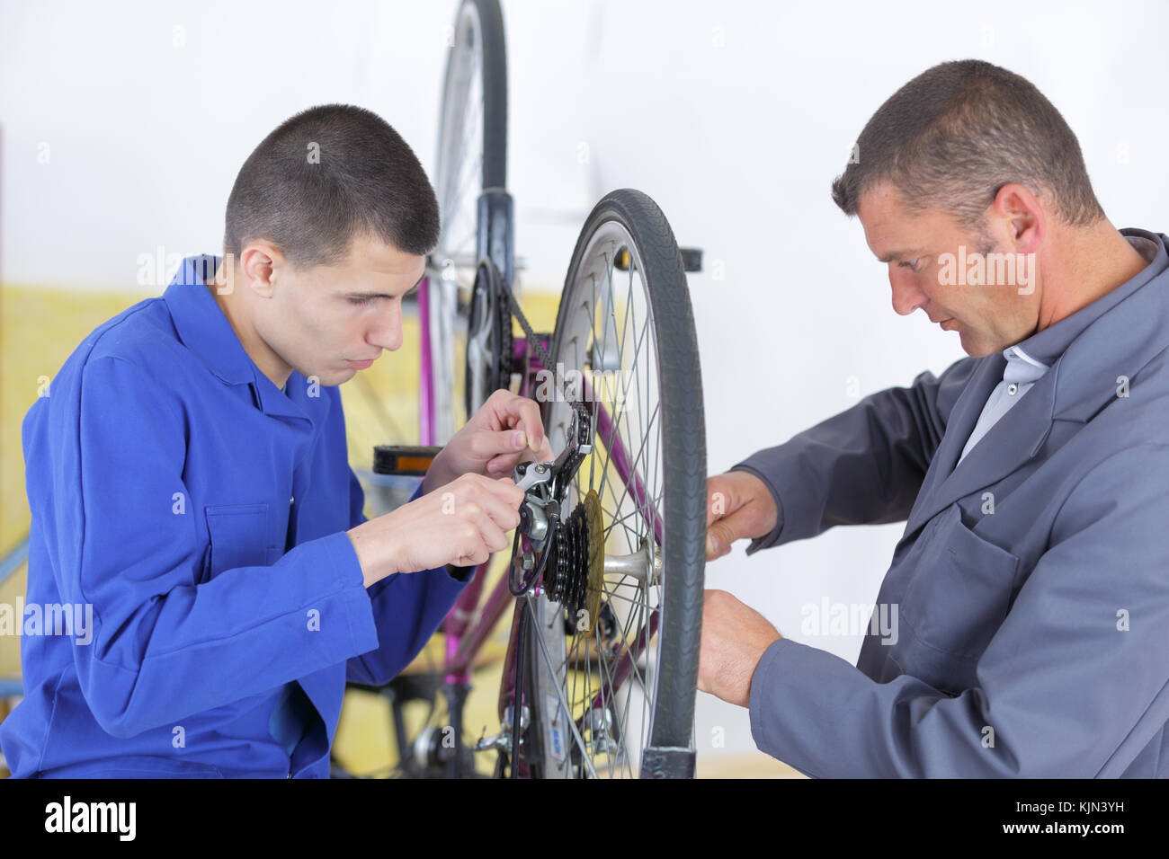 Son repairing bike hi-res stock photography and images - Alamy