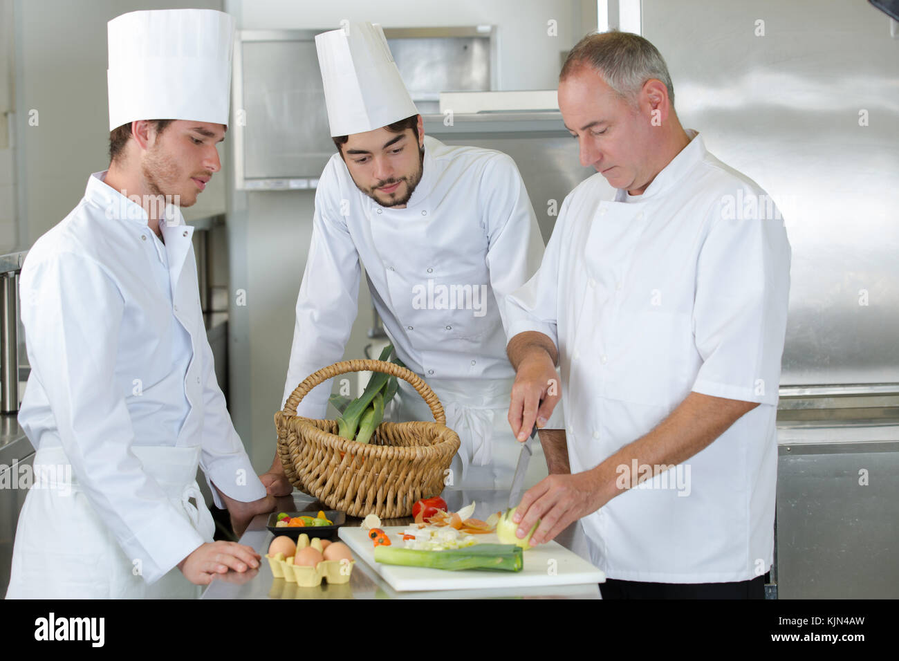 cook in uniform chopping veggies for vegetarian stew Stock Photo - Alamy