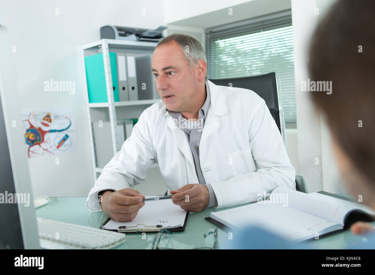 doctor checking computer with clipboard Stock Photo - Alamy