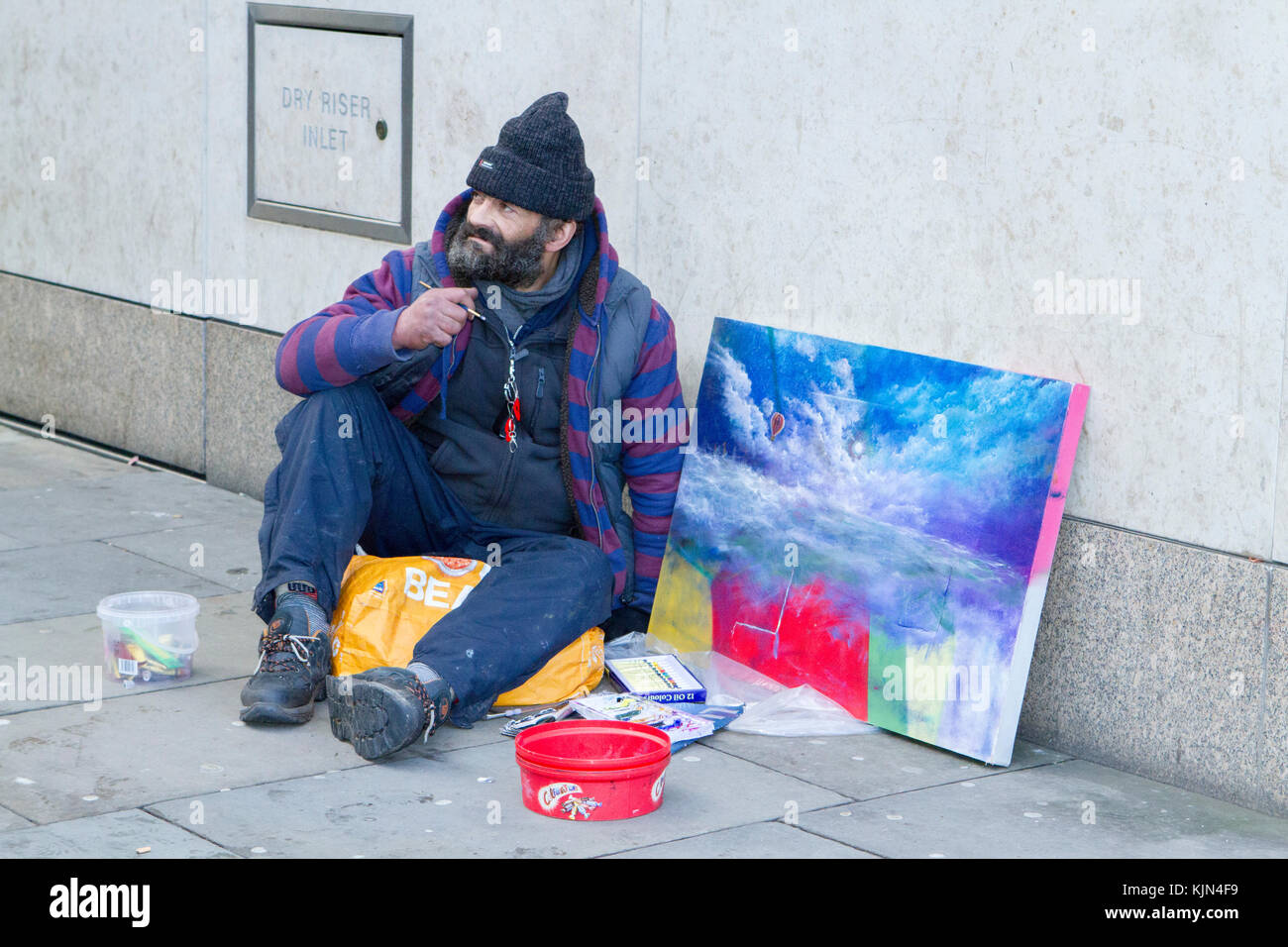 Street artist; sleeping rough beg beggar begging hungry cold winter sad ...
